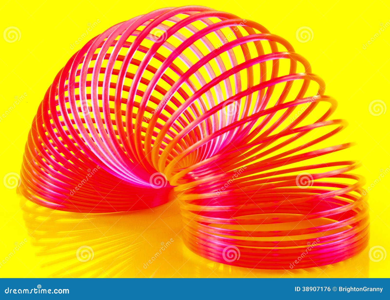 Bright red plastic slinky. editorial photo. Image of flexible - 38907176