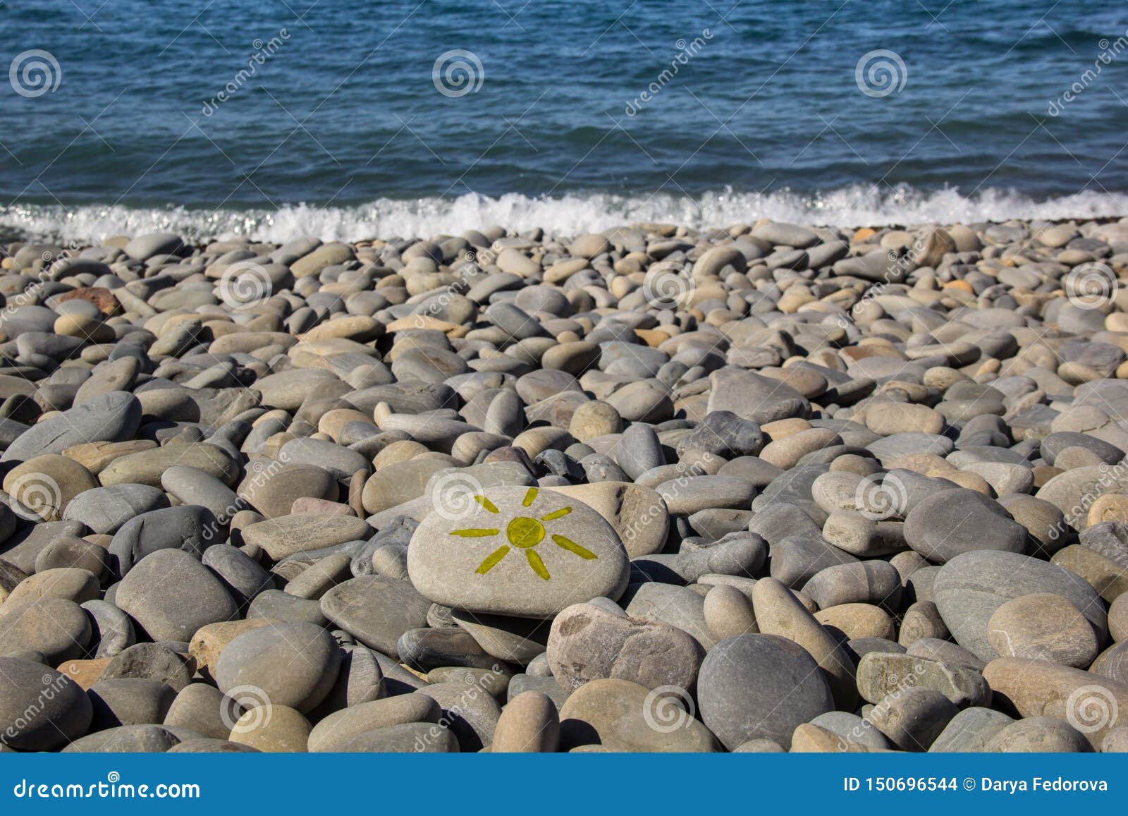 Bright Sun Painted on Pebble. Pebbles and Sea Background Stock Photo ...