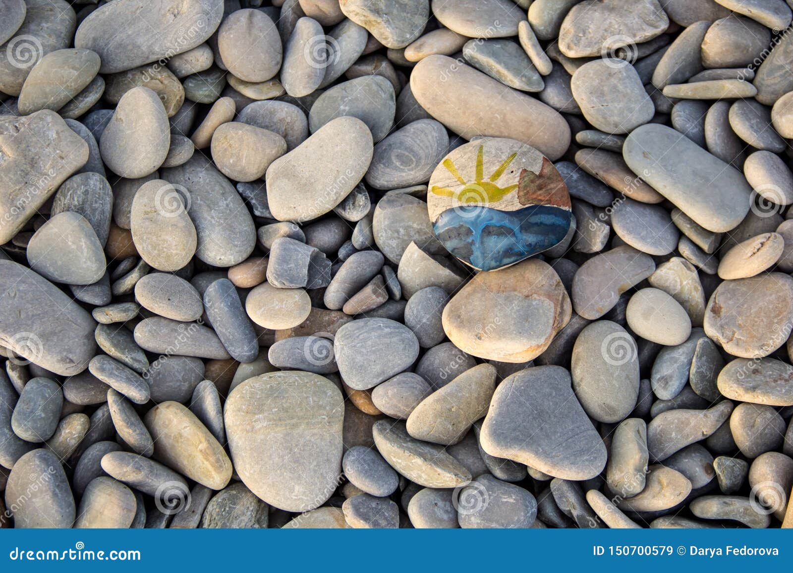 Bright Sun Painted on Pebble. Pebbles and Sea Background Stock Image ...