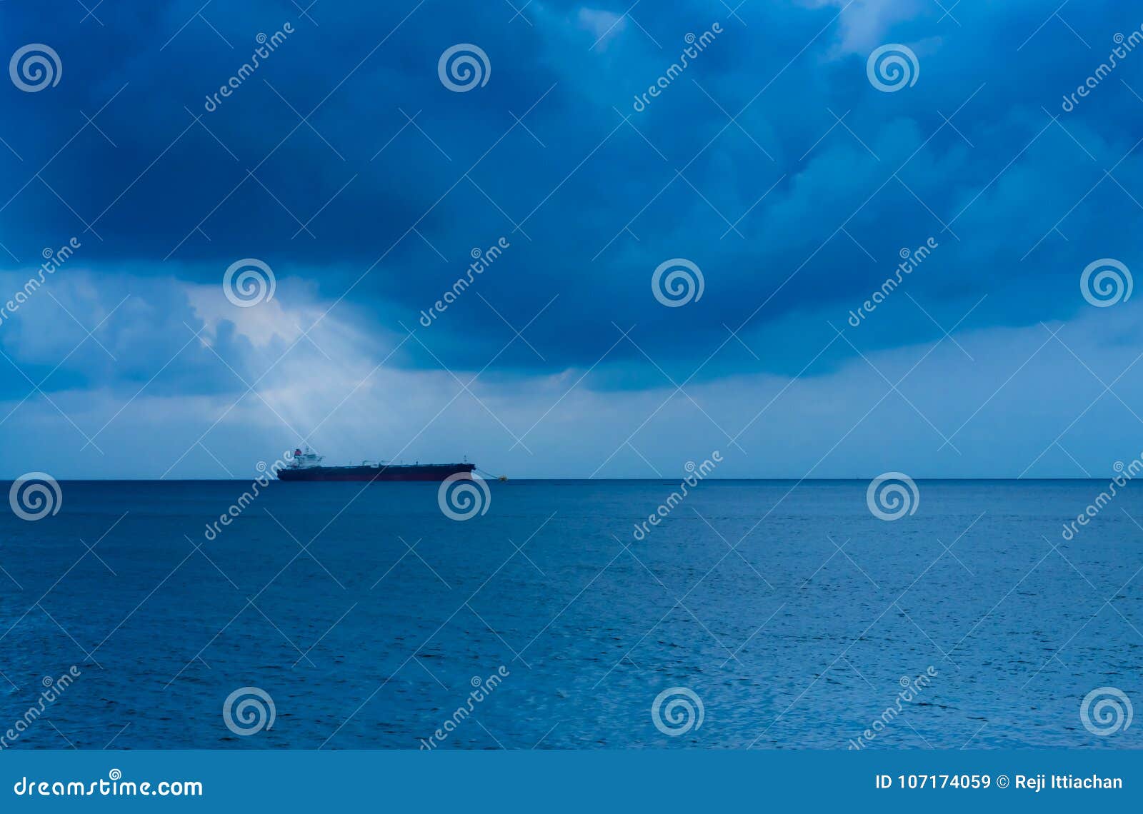 Sun Rays through Dark Clouds Over a Ship Stock Image - Image of ...