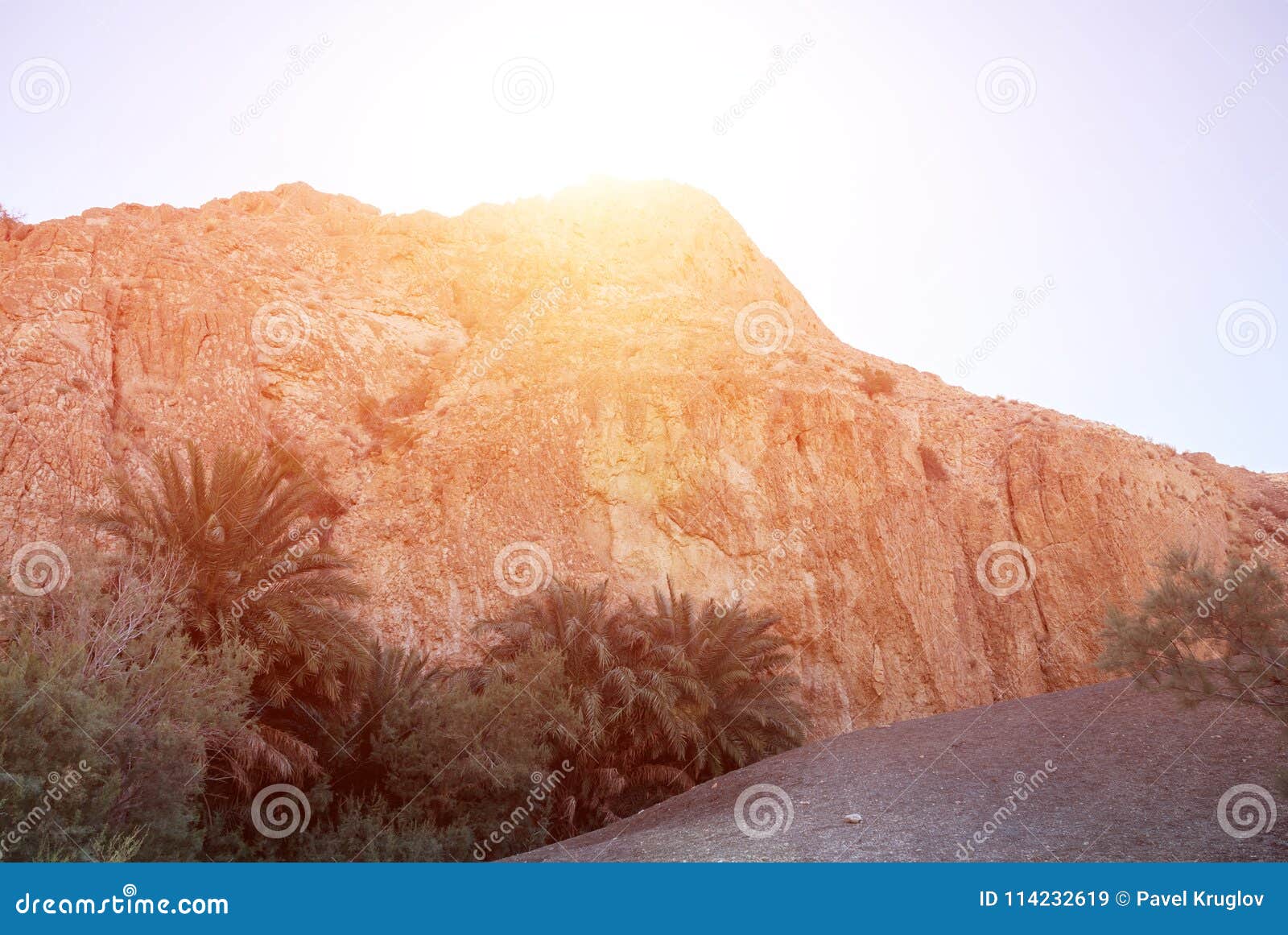 Bright Sun at the Zenith Behind the Silhouette of a Mountain Stock ...