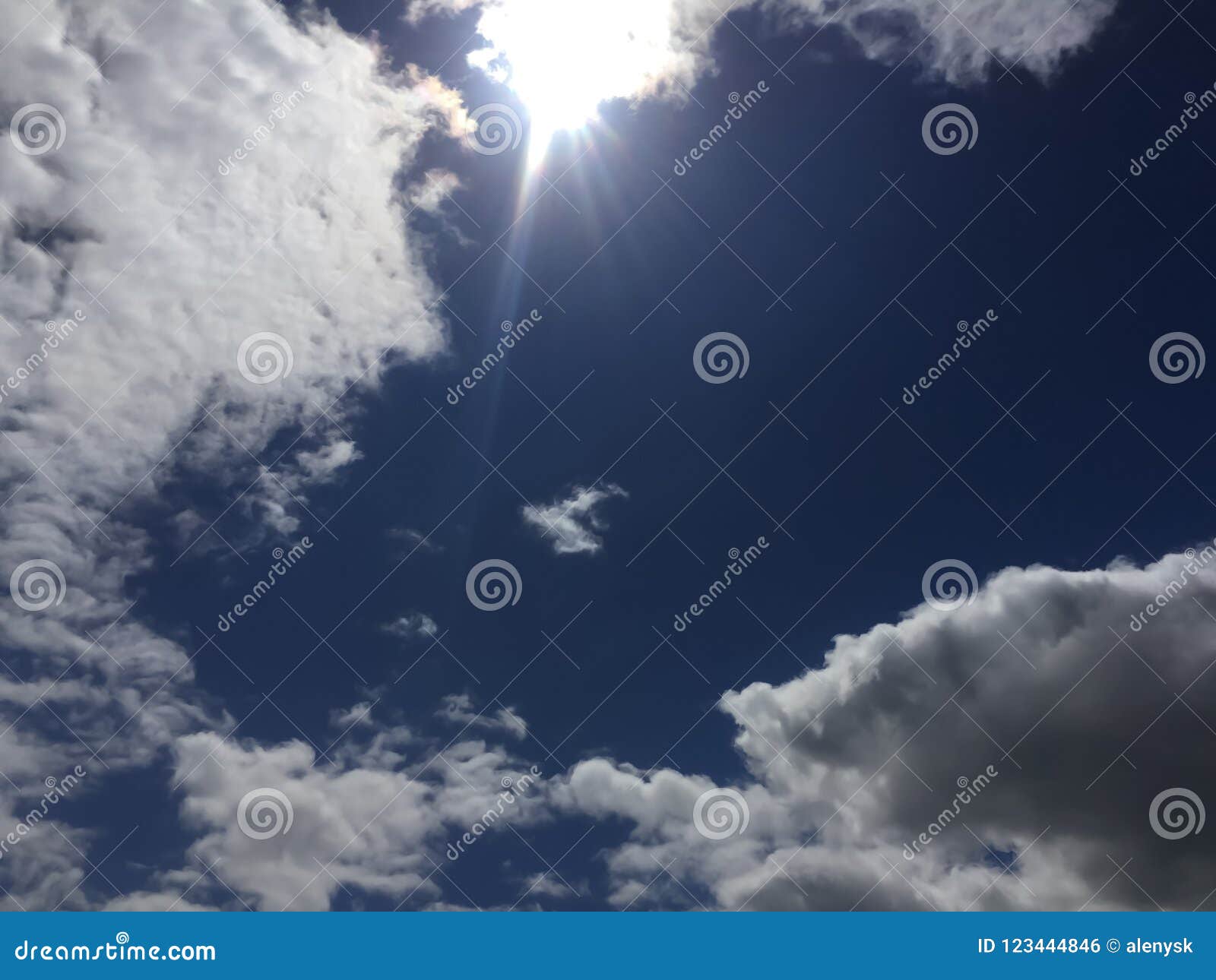 Bright Sunlight Against a Blue Sky with Clouds, Rays of the Sun. Stock ...