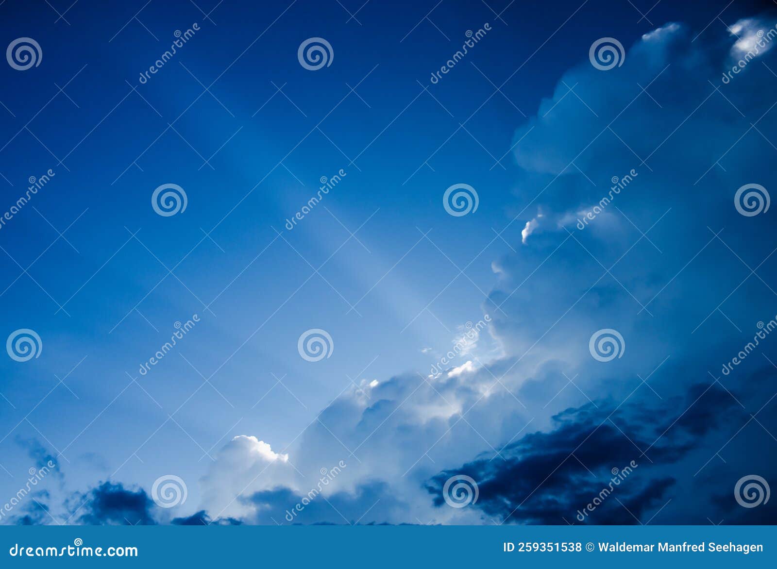 Bright Sunlight Rays in Blue Sky with Luminous Clouds. Stock Photo ...