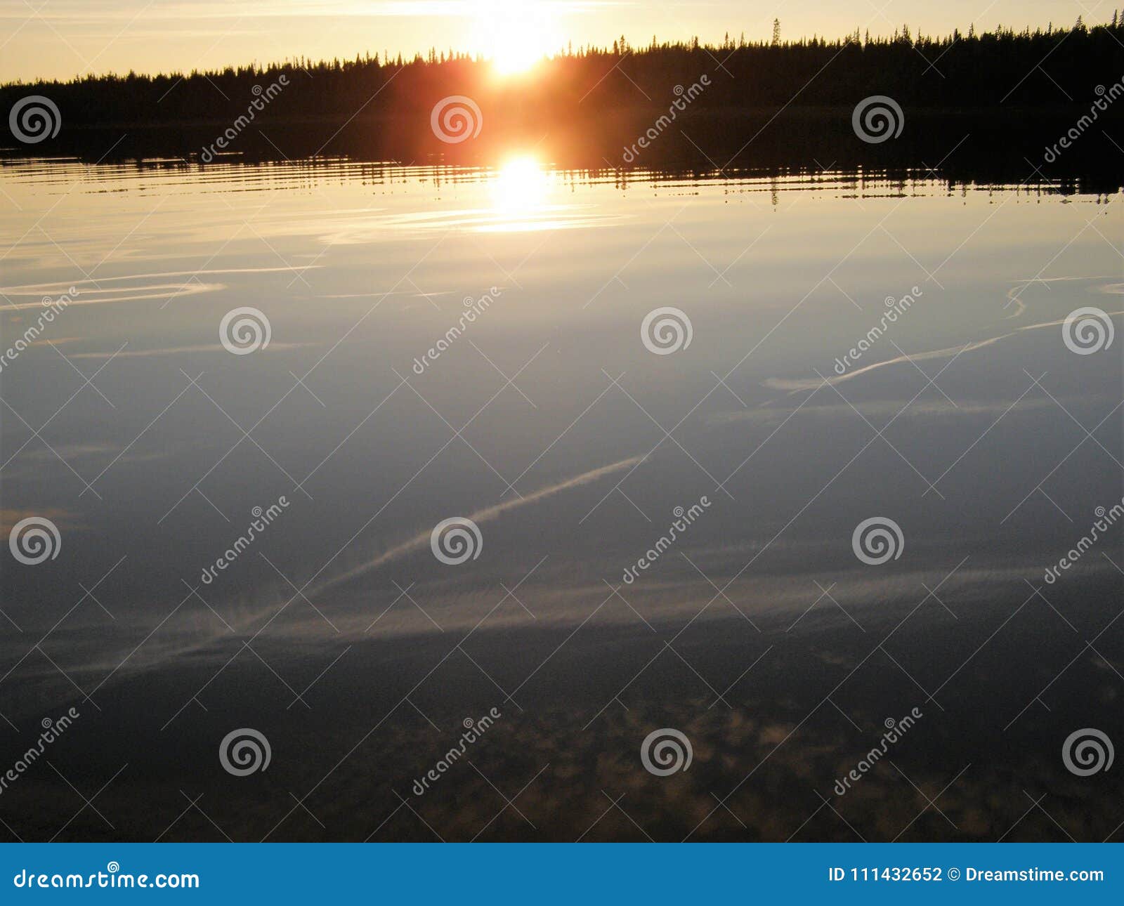 A Bright Sunset Over the River in Which the Sky Reflects Stock Photo ...