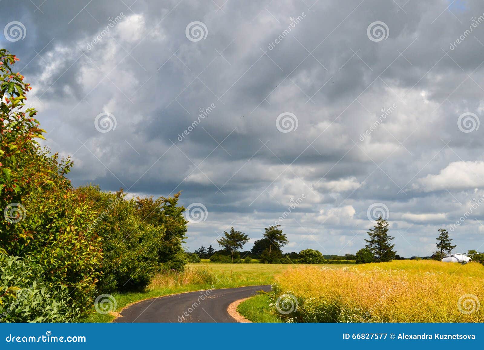 Bright Sunshine and Big Rain Clouds Over the Road in Denmark Stock ...