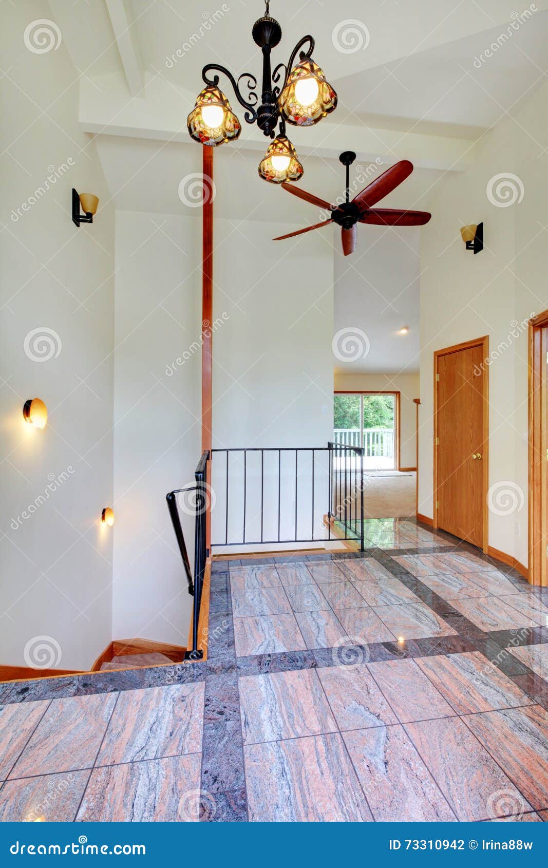Bright Upstairs Hallway with Tile Floor, High Ceiling and Staircase ...