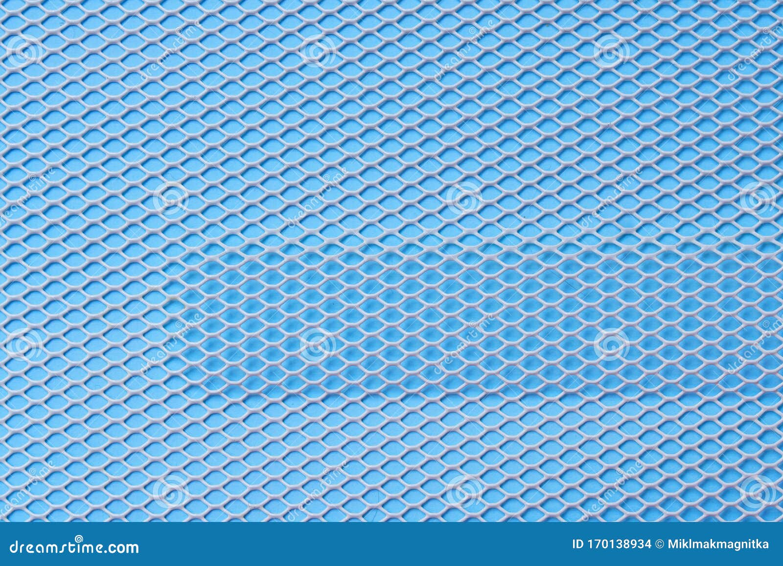 Bright White Metal Mesh with Small Cells on a Blue Background with a ...