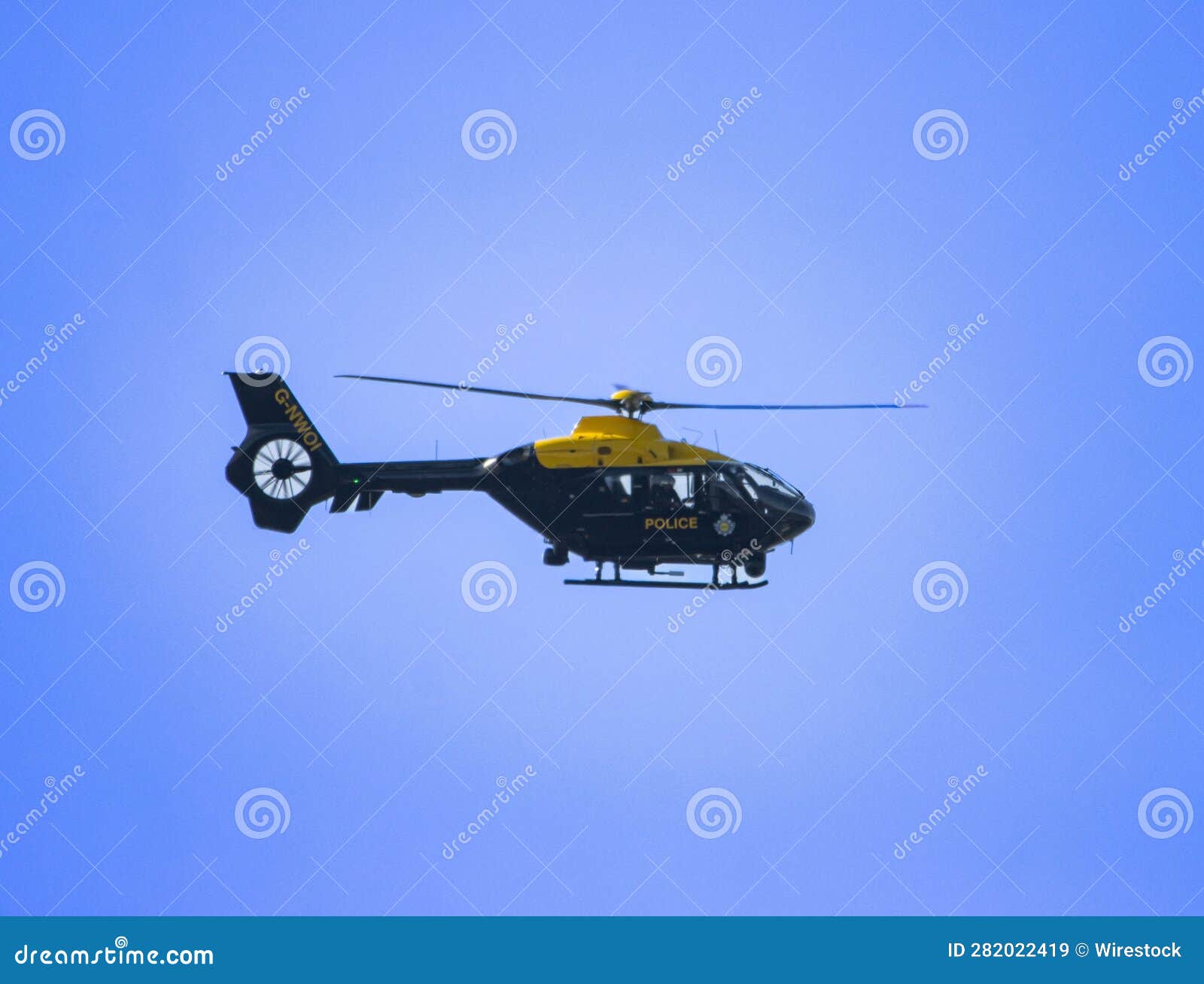 A Large Yellow Helicopter Flying through a Blue Sky of Some Sort ...