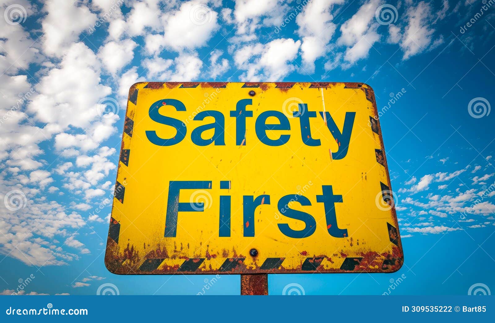 Bright Yellow Safety First Sign Against a Vibrant Blue Sky with Fluffy ...