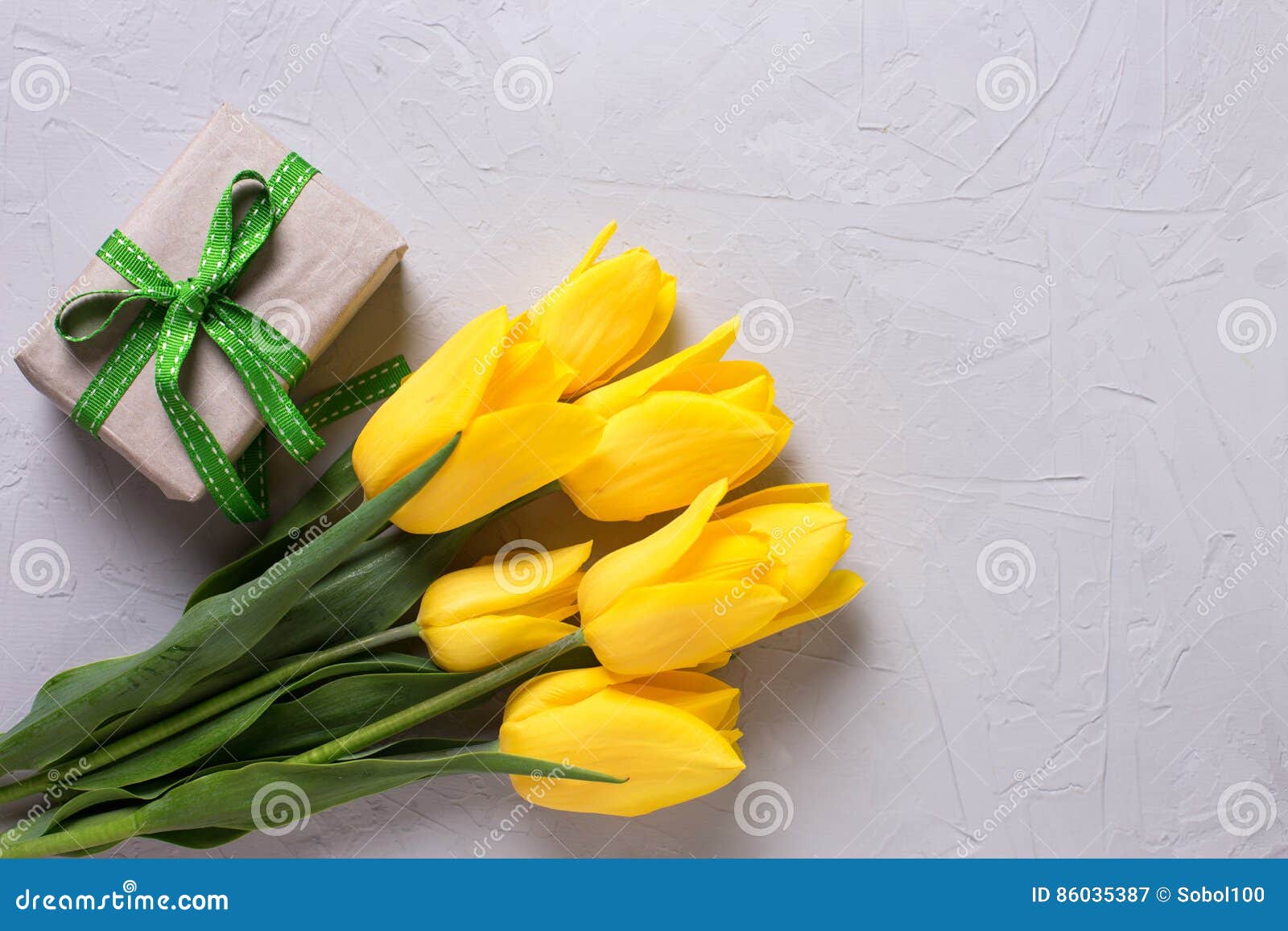Bright Yellow Tulips and Box with Gift on Grey Textured Backgro Stock ...