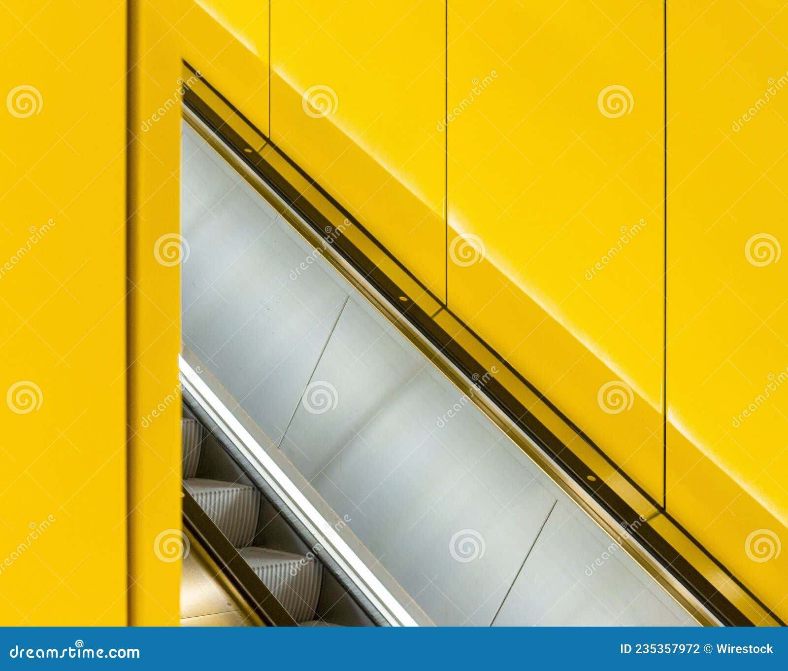 Bright Yellow Wall Next To an Escalator Stock Photo - Image of urban ...