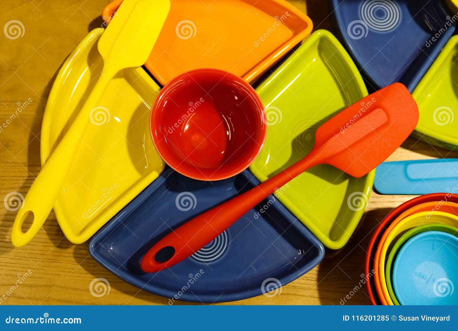 Brightly Colored Serving Dishes and Plasticware - Top View on Wooden ...