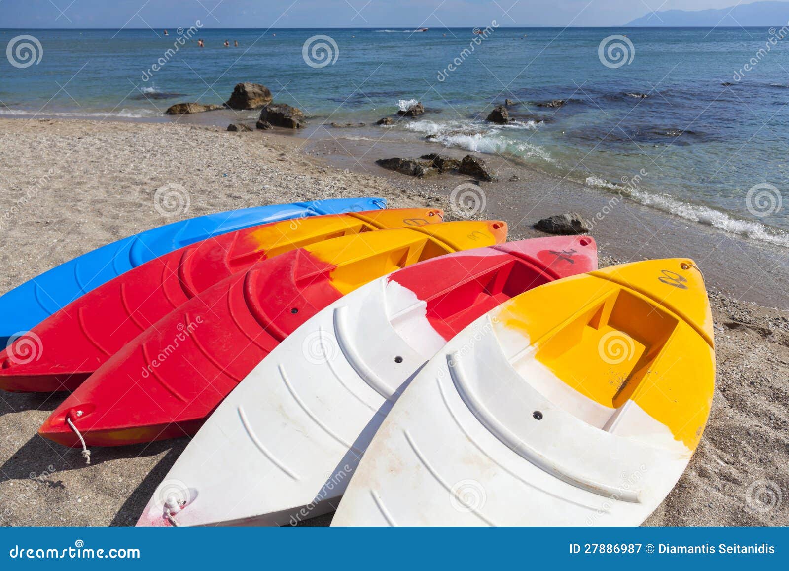 Brightly coloured canoes stock image. Image of beach - 27886987