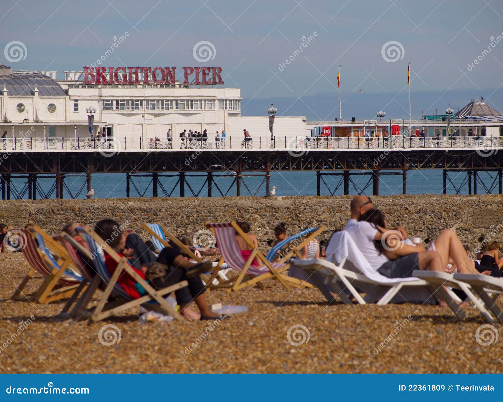Brighton Pier with People Relaxing on the Beach Editorial Stock Image ...