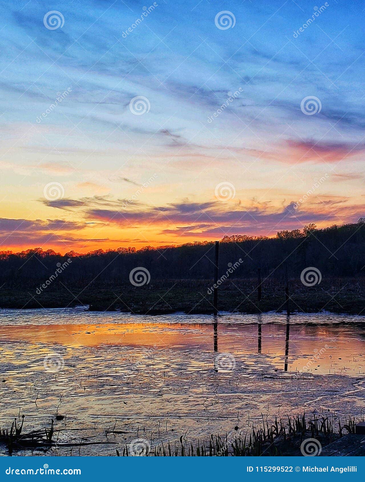 Marsh sunset reflection. stock photo. Image of still - 115299522
