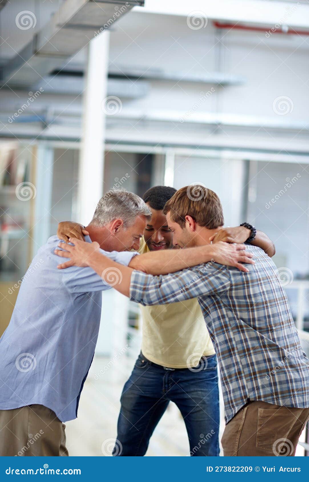 Bring it in Boys. Three Coworkers Huddled Together at the Office. Stock ...