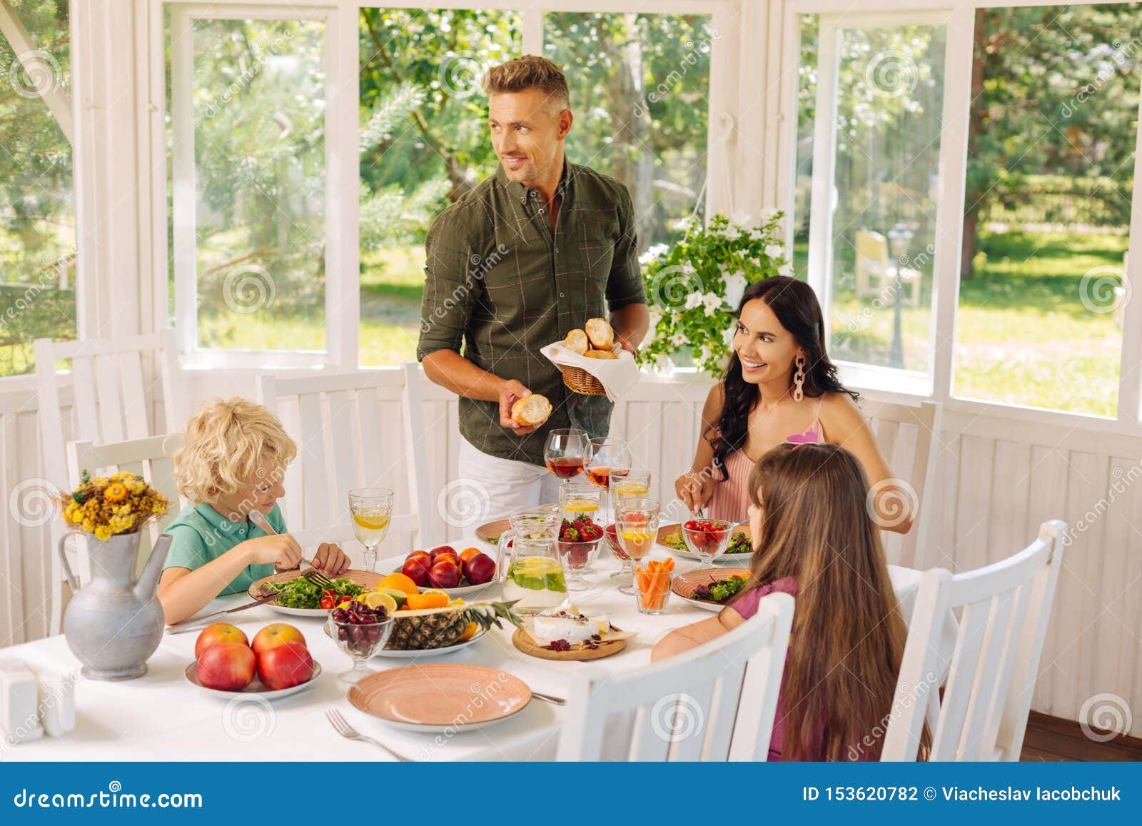 Daddy Bringing Some Bread while Having Family Lunch Outside Stock Photo ...