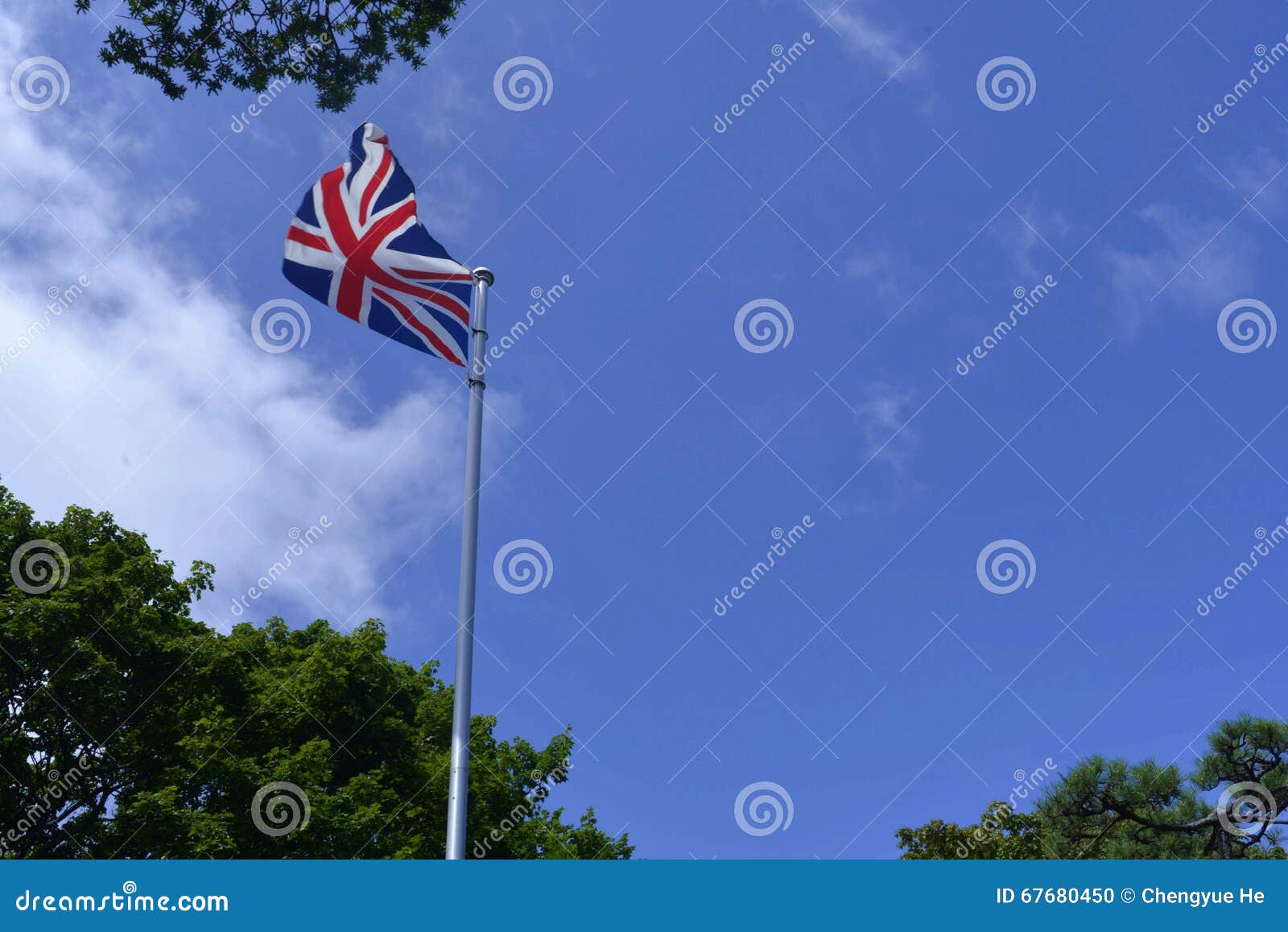 The British Flag Flying in the Blue Sky. Stock Photo - Image of british ...