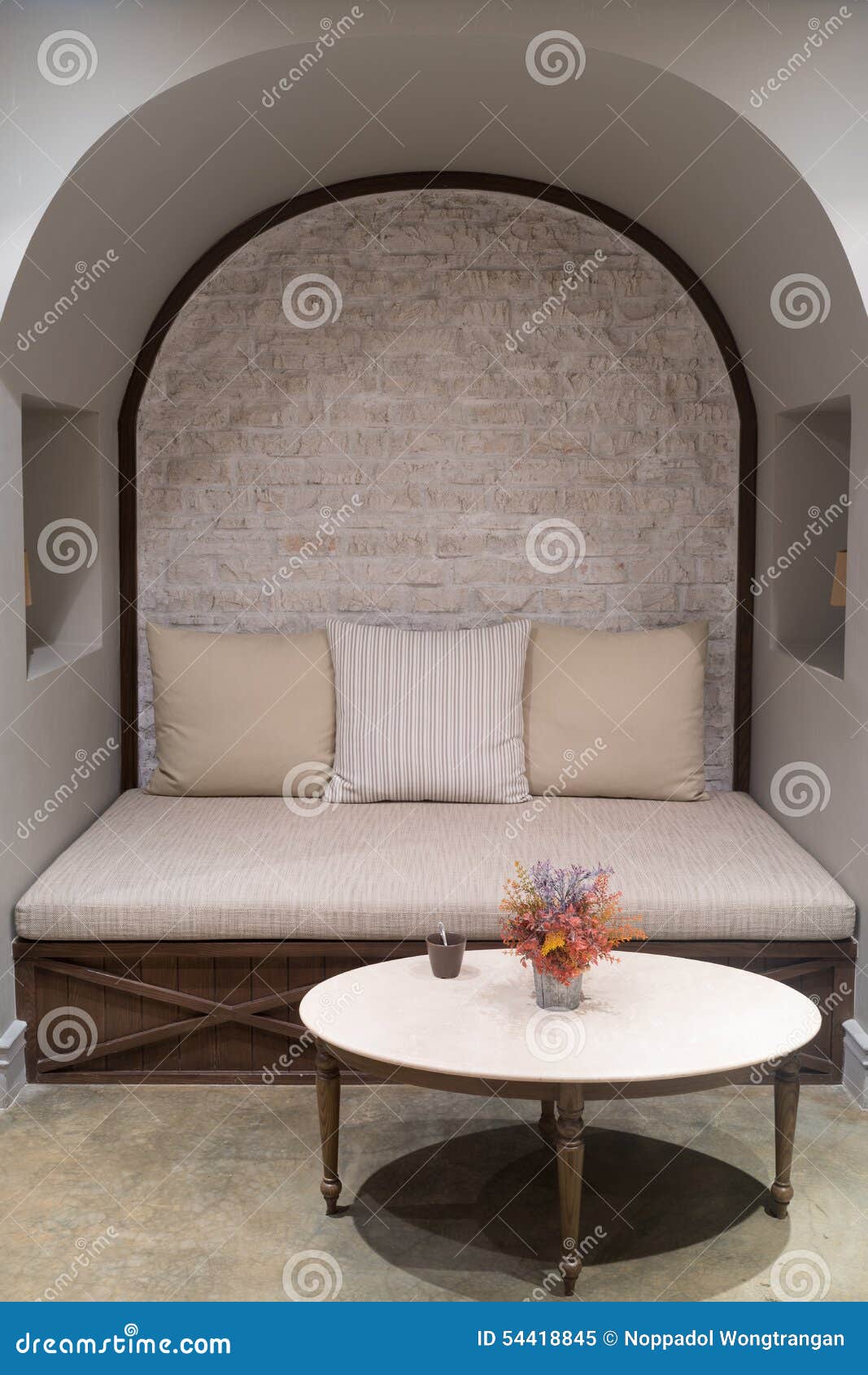British Style Living Corner with Sofa and Table Against Brick Wall ...