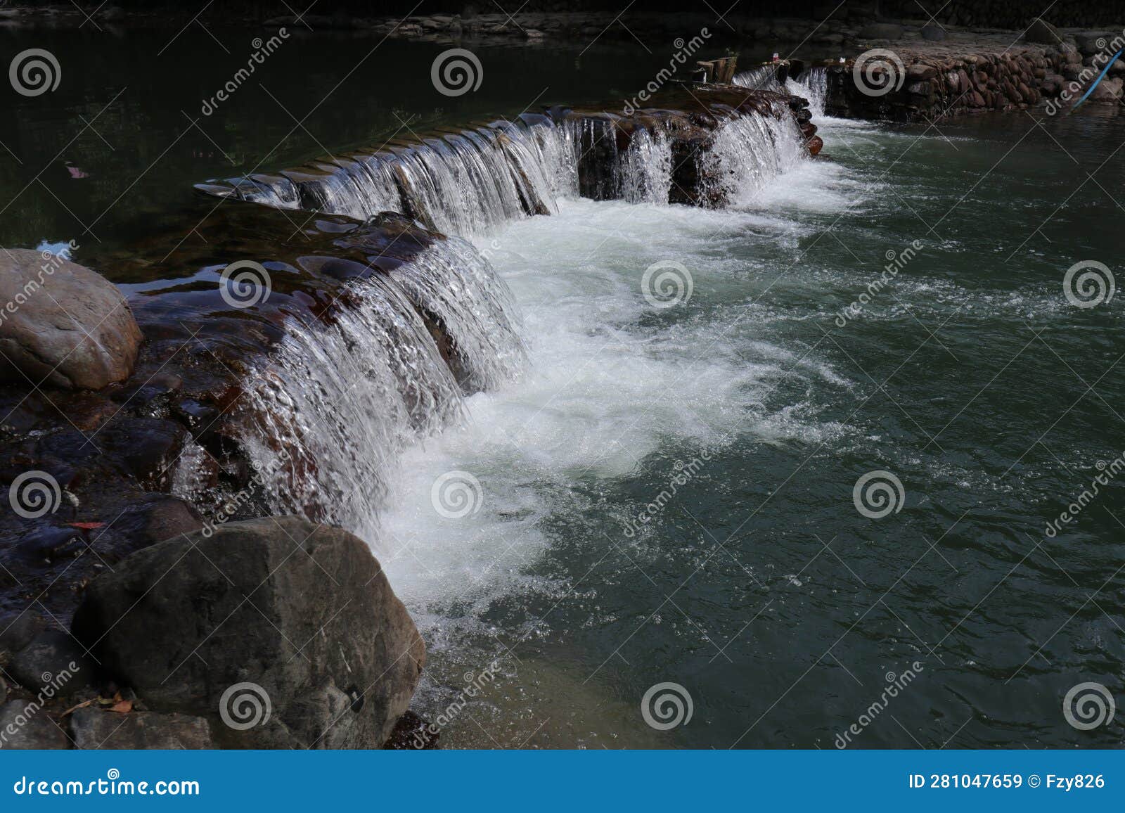A Broad Dam Spans Across the River Stock Image - Image of making ...