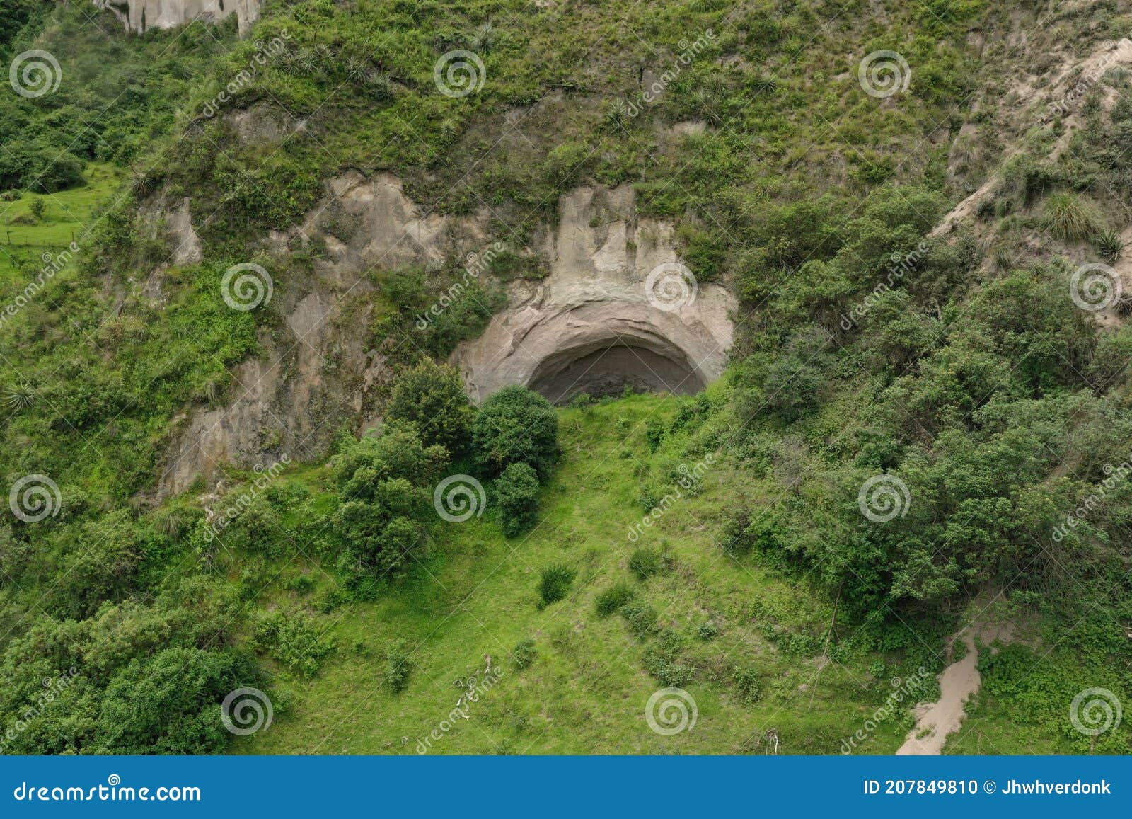 The Broad Entrance of a Large Cave Seen from the Distance Stock Photo ...