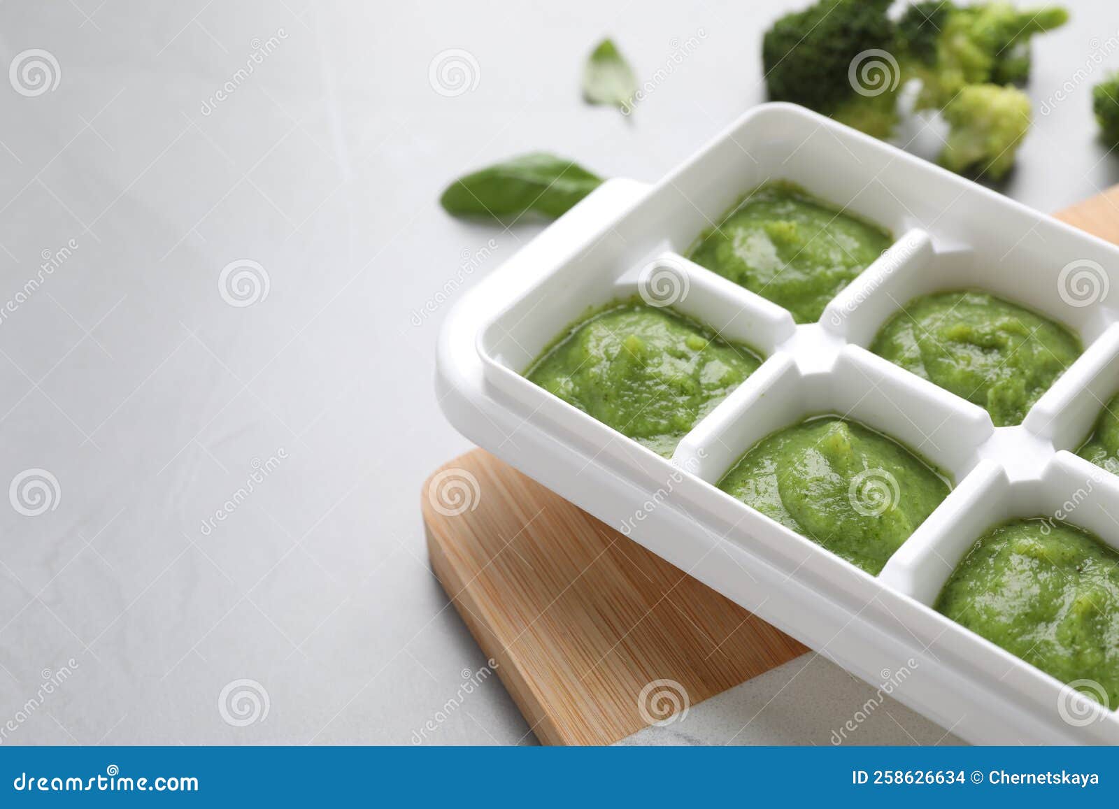 Broccoli Puree in Ice Cube Tray Ready for Freezing and Ingredients on ...