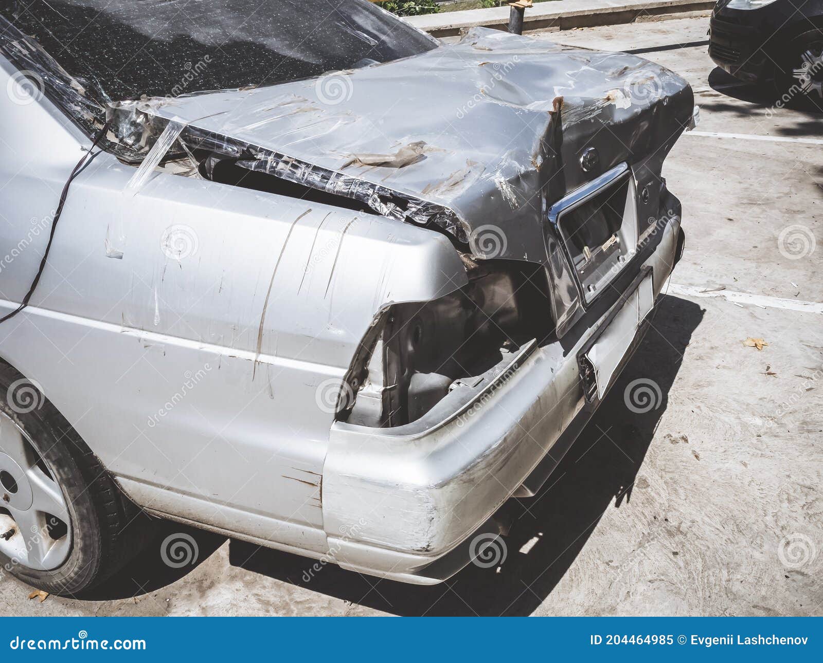 Broken Back of a Silver Car with a Dented Trunk, Rewound Tape and ...