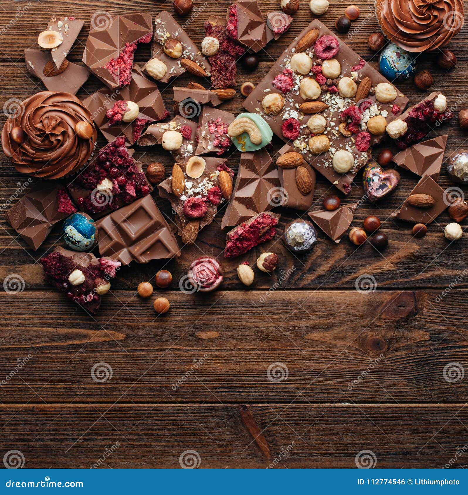 Broken Bars of Chocolate with Nuts and Chocolate Candies on Rust Stock ...
