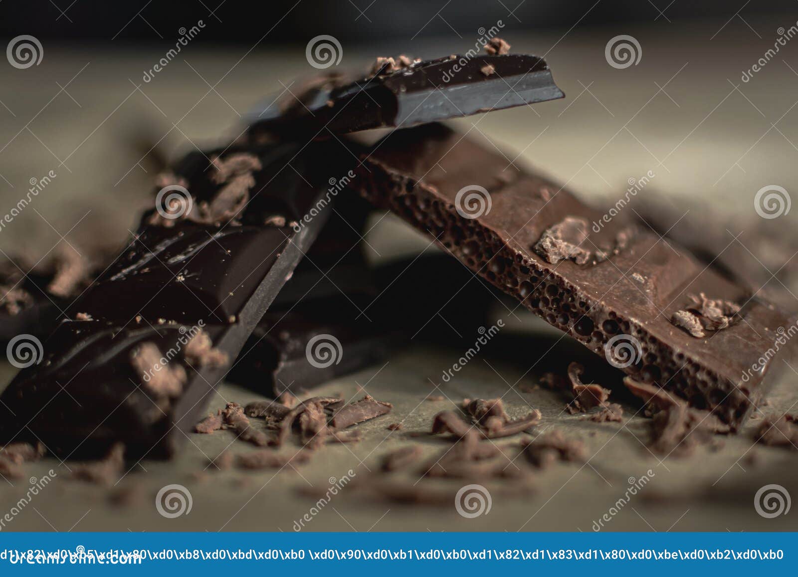 Broken Bars of Different Chocolate Stacked on a Light Background Stock ...
