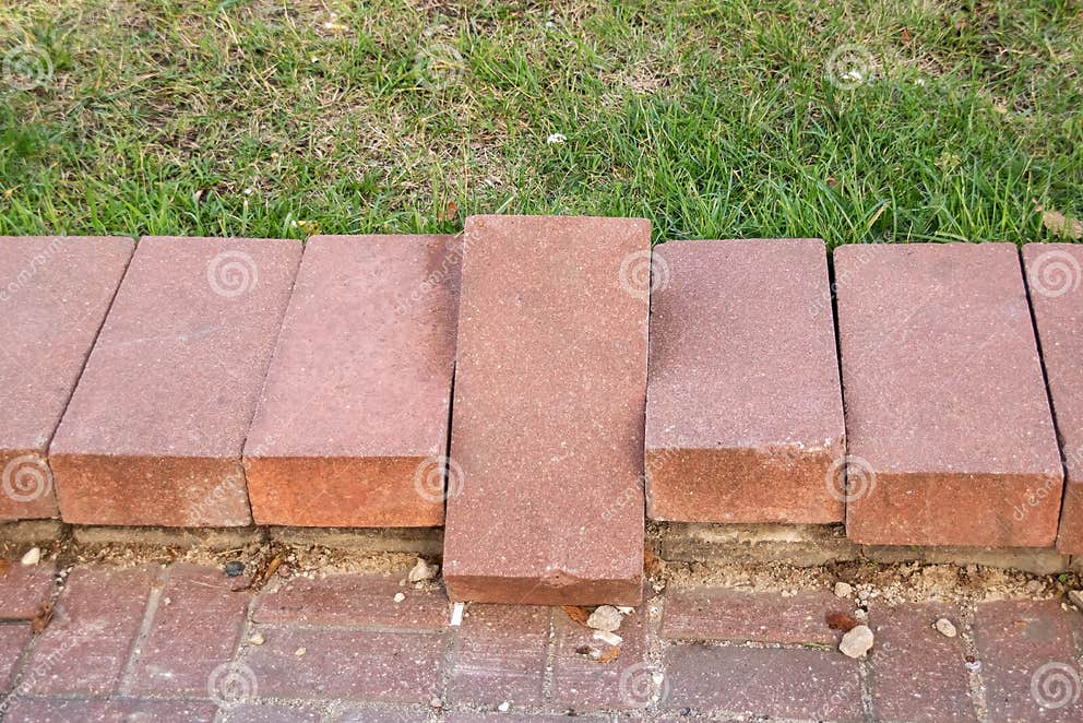 Broken Brick Sticking Out of the Sidewalk Stock Photo - Image of ...