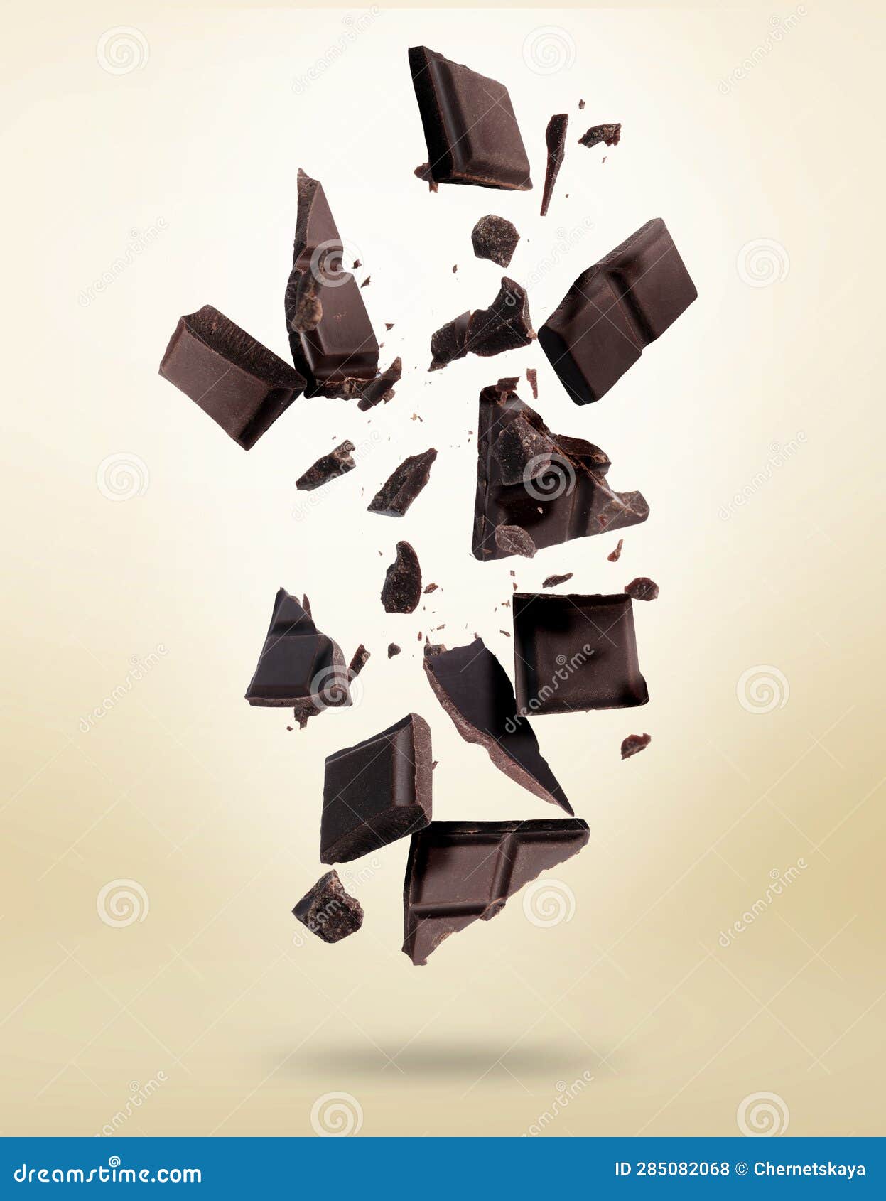 Broken Chocolate Bar Pieces Falling on Beige Background Stock Photo ...
