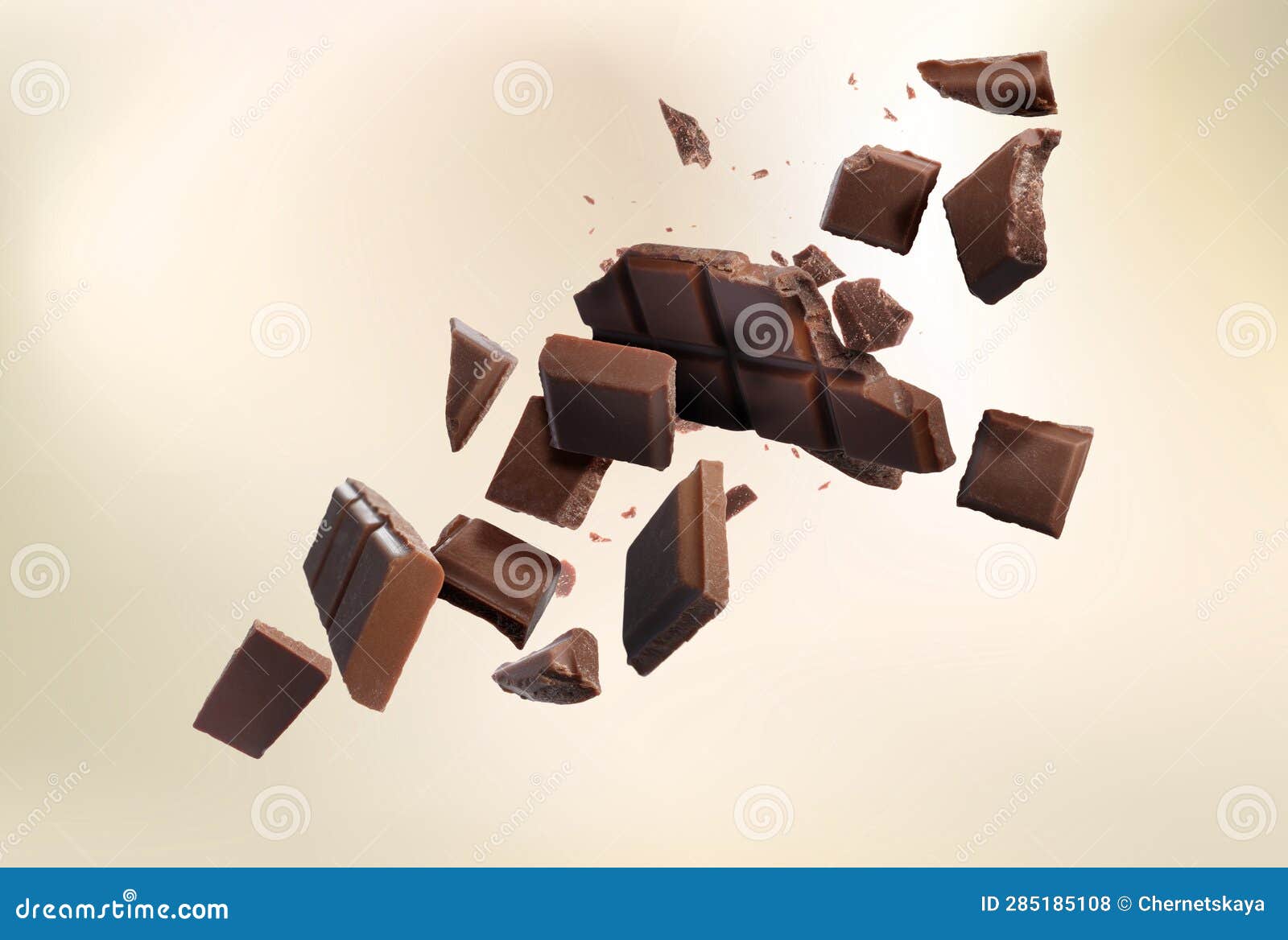 Broken Chocolate Bar Pieces Falling on Beige Background Stock ...