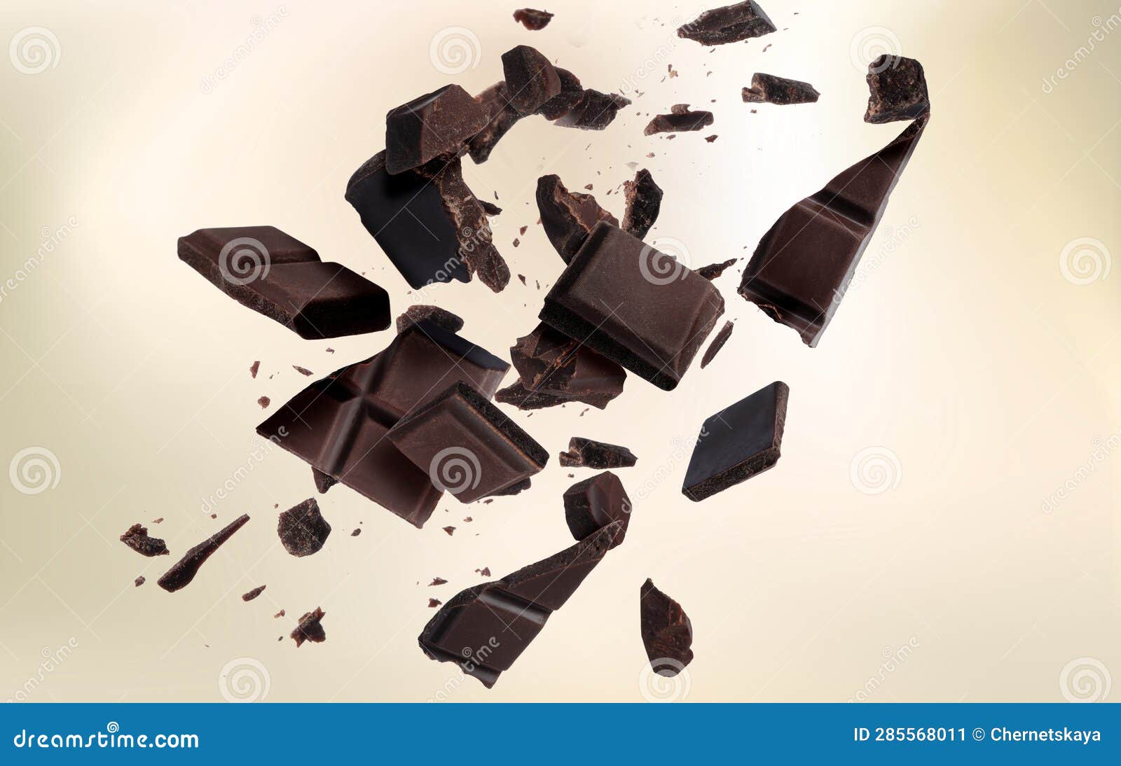 Broken Chocolate Bar Pieces Falling on Beige Background Stock Image ...