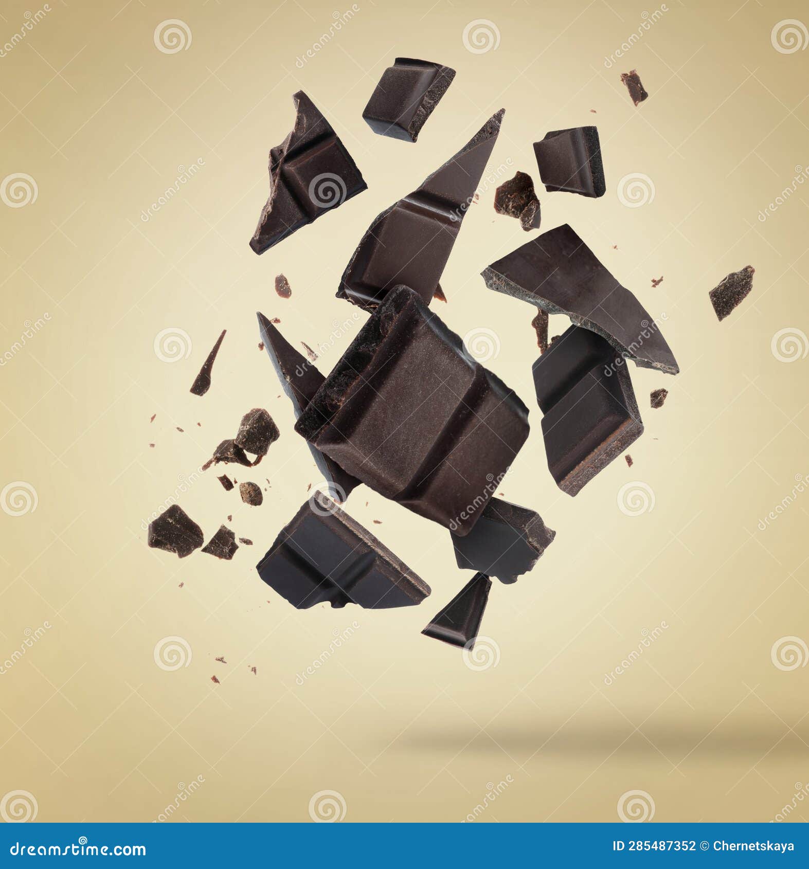 Broken Chocolate Bar Pieces Falling on Beige Background Stock Photo ...