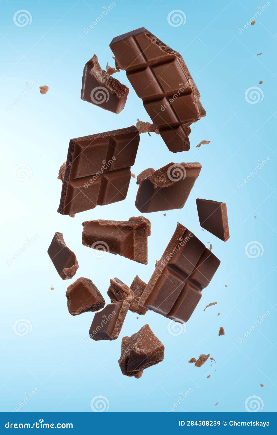 Broken Chocolate Bar Pieces Falling on Light Blue Background Stock ...