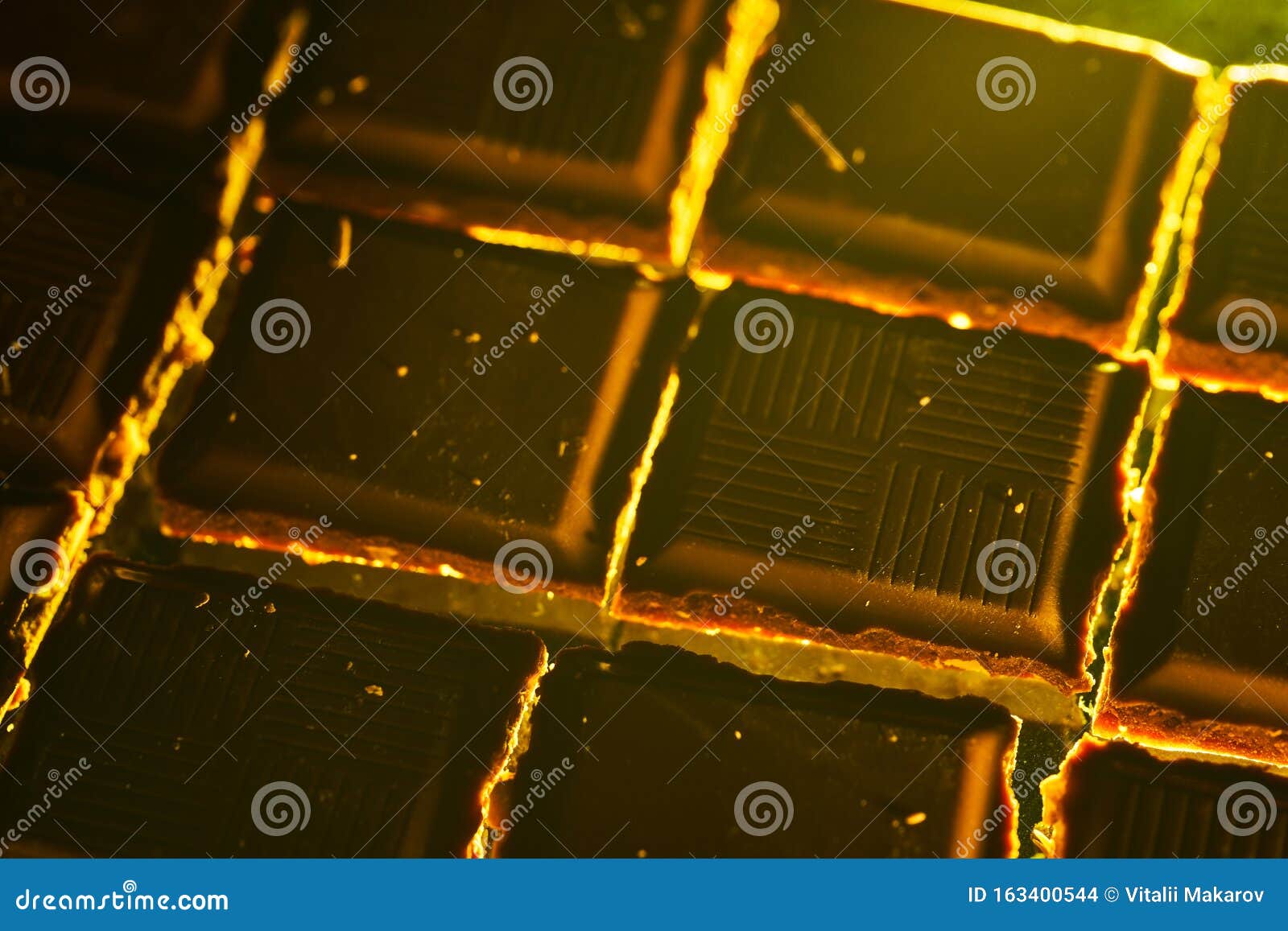 A Broken Chocolate Bar with a Yellow Light Inside. Chocolate Explosion ...