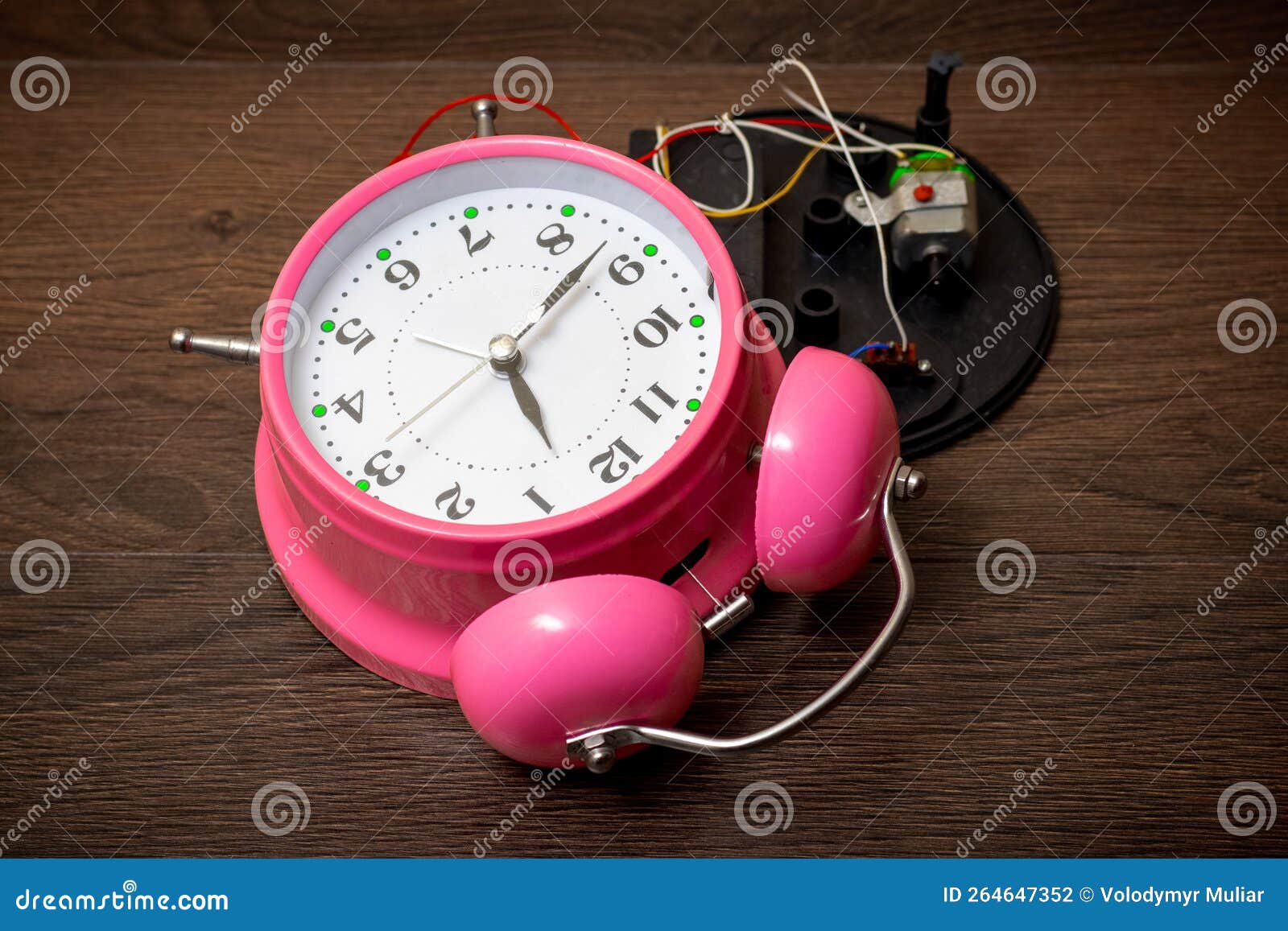 A Broken Clock, an Alarm Clock, Lies on the Wooden Floor Stock Photo ...