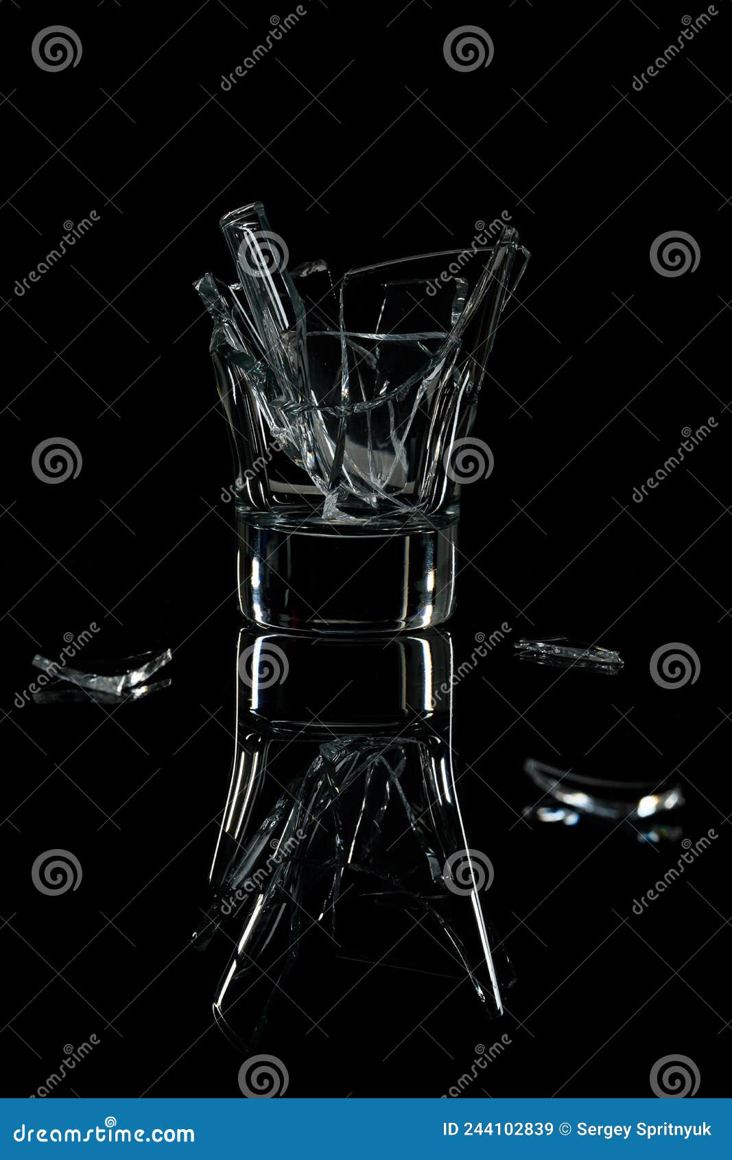 A Broken Cocktail Glass on a Black Mirror Surface Stock Image - Image ...