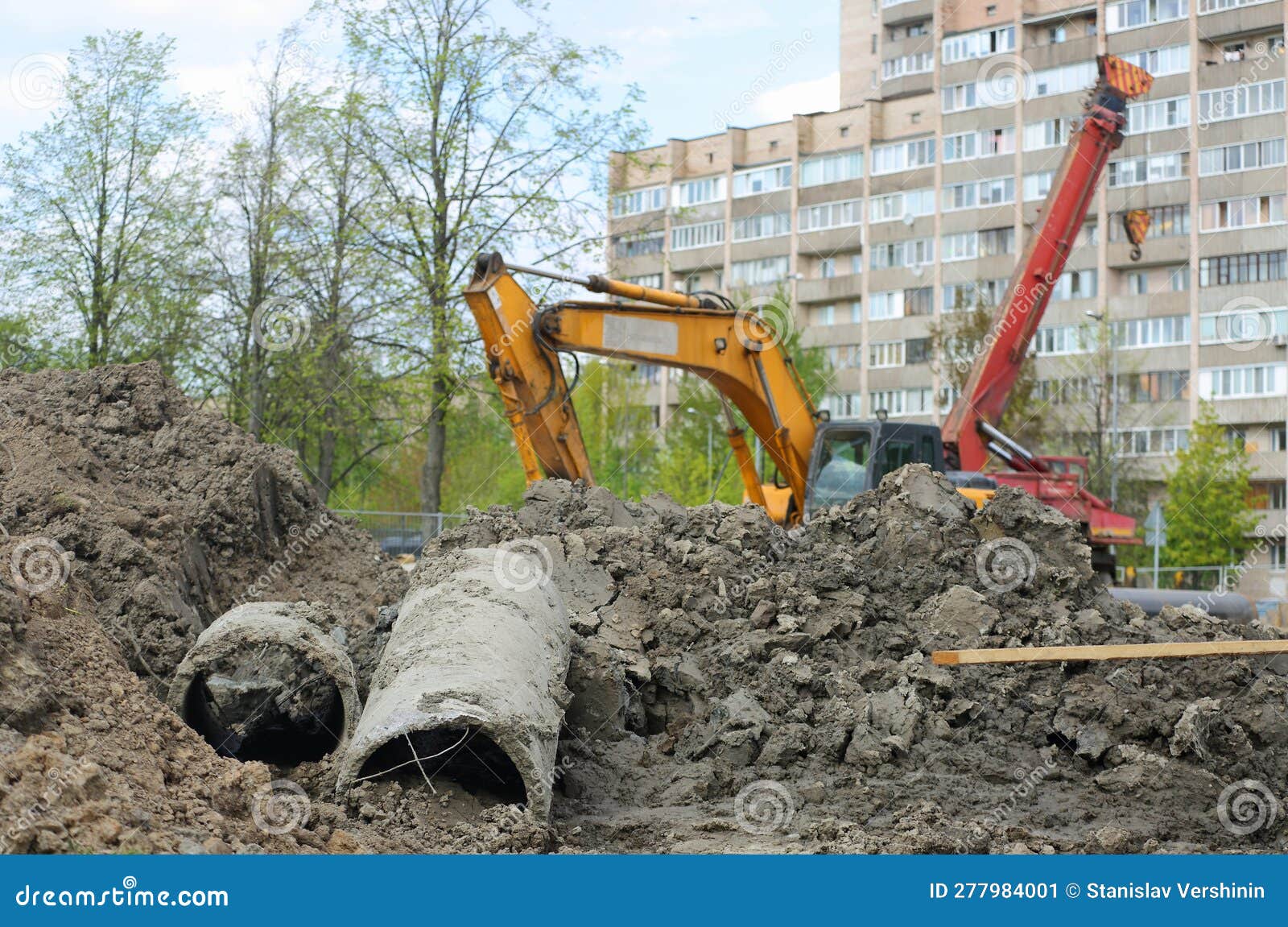 Broken Concrete Pipe in a Pile of Soil at a Construction Site Stock ...