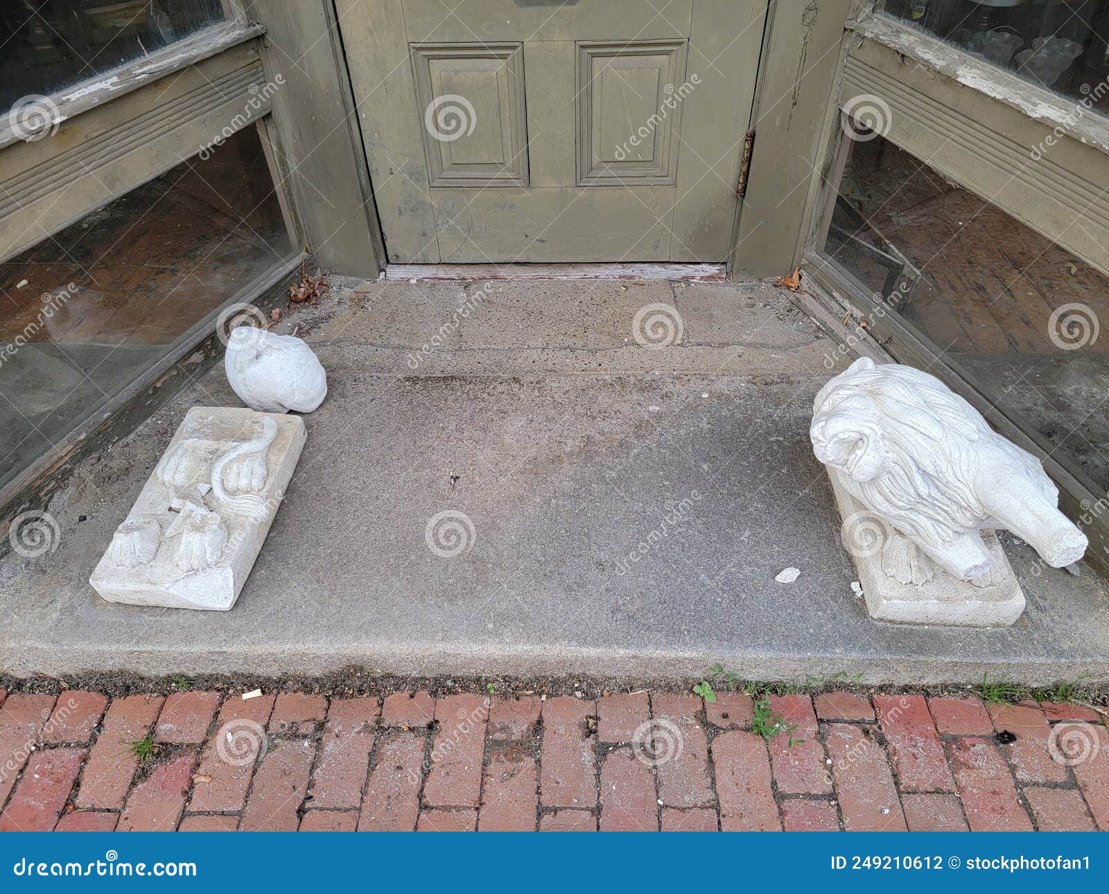 Broken or Damaged Lion Statues on the Ground with Door Stock Photo ...