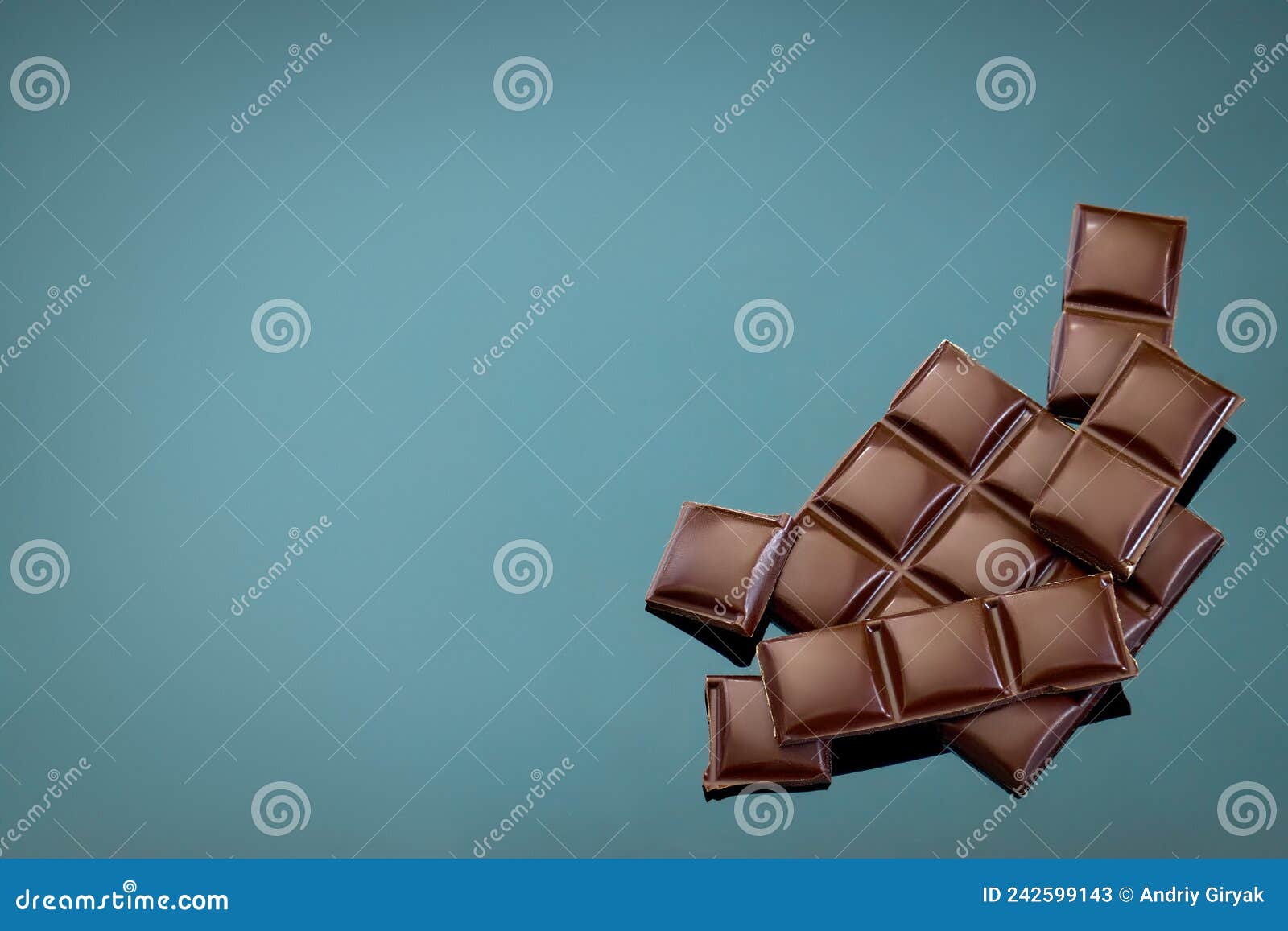 Broken Dark Chocolate Bar on a Blue Background, Space for Text. Stock ...