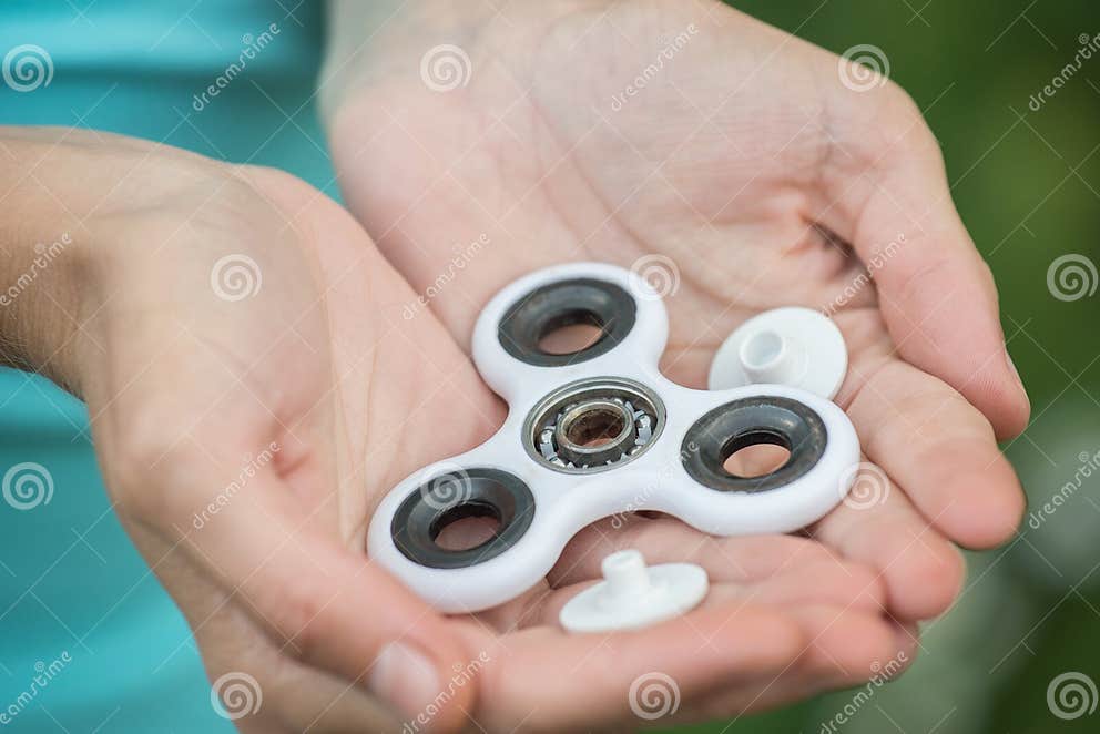 Broken Details of a White Spinner in the Hands Stock Image - Image of ...