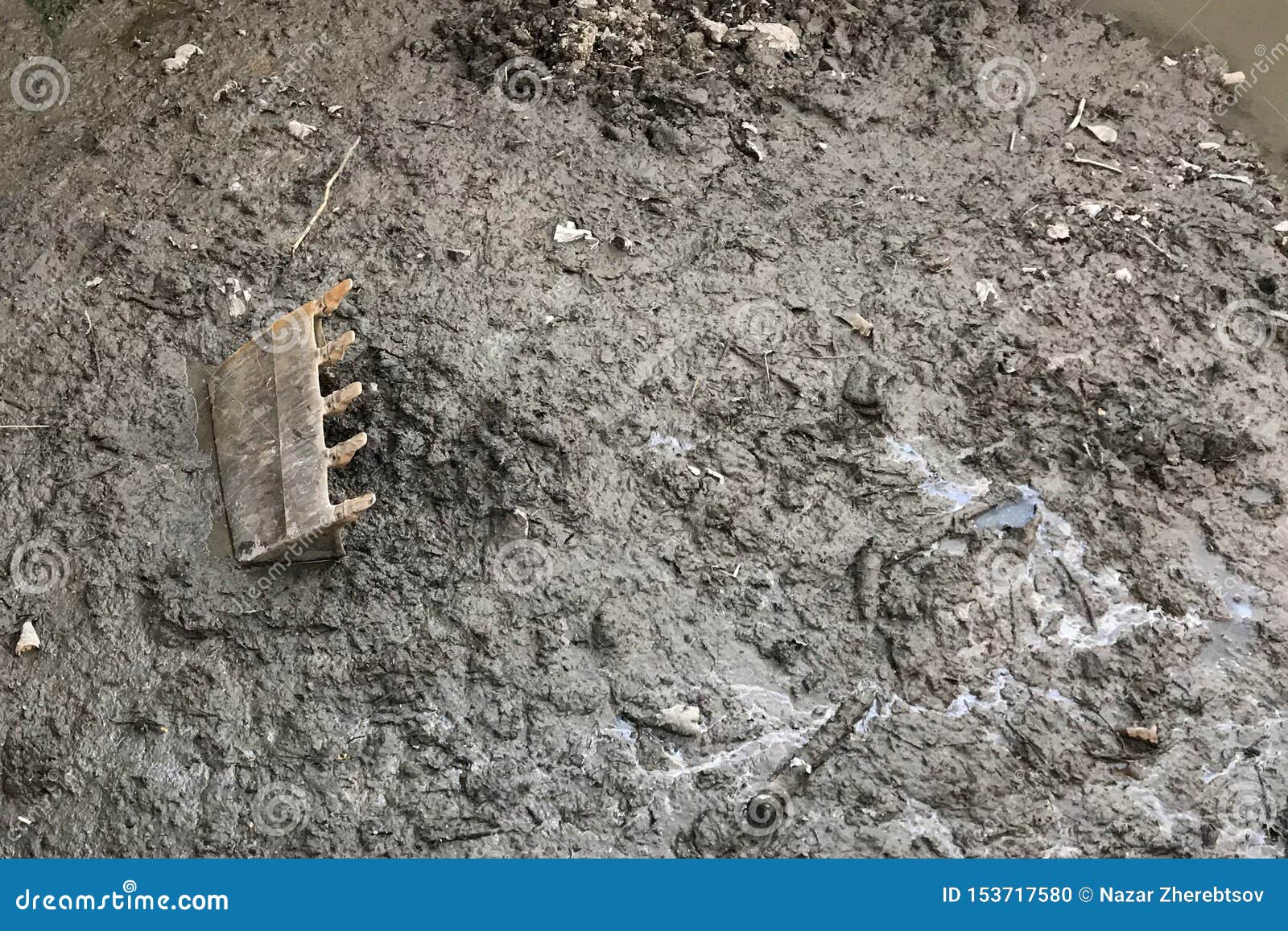 Broken Excavator Bucket Sticking Out of the Mud Stock Photo - Image of ...