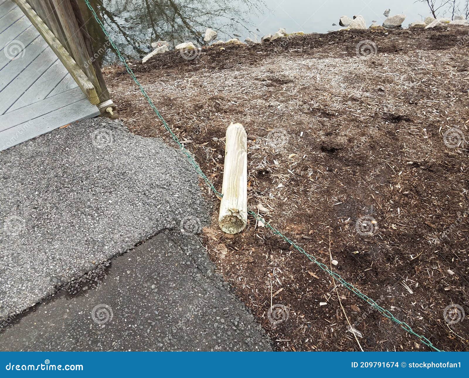Broken Fence Post with Chain and Asphalt Path Stock Photo - Image of ...