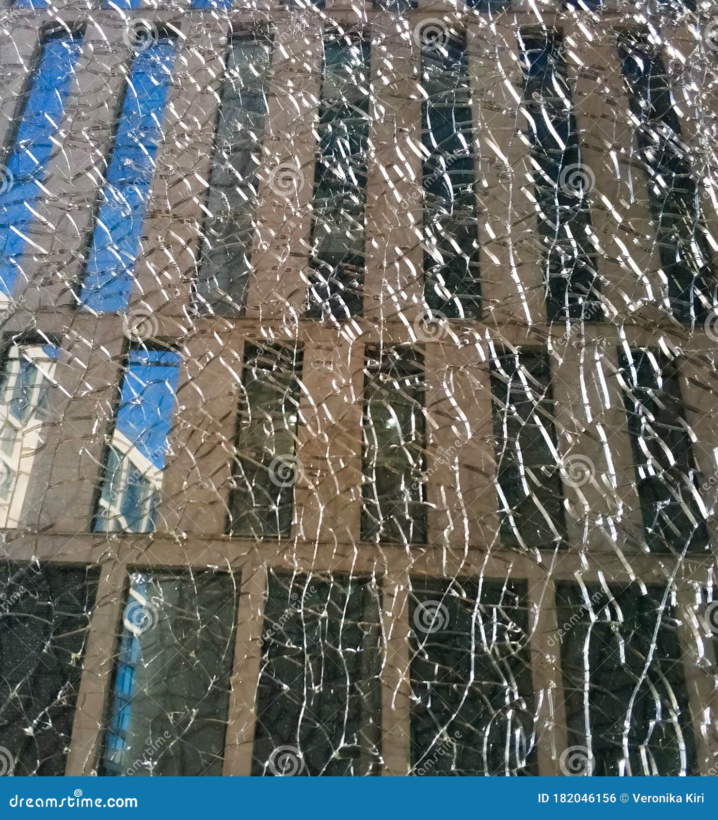 Through the Broken Glass, the Facade of the Building with Blue Windows ...