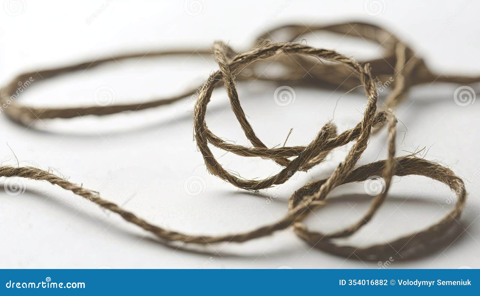 Broken Guitar String Coils on Plain Surface Evoking Feelings of Loss in ...