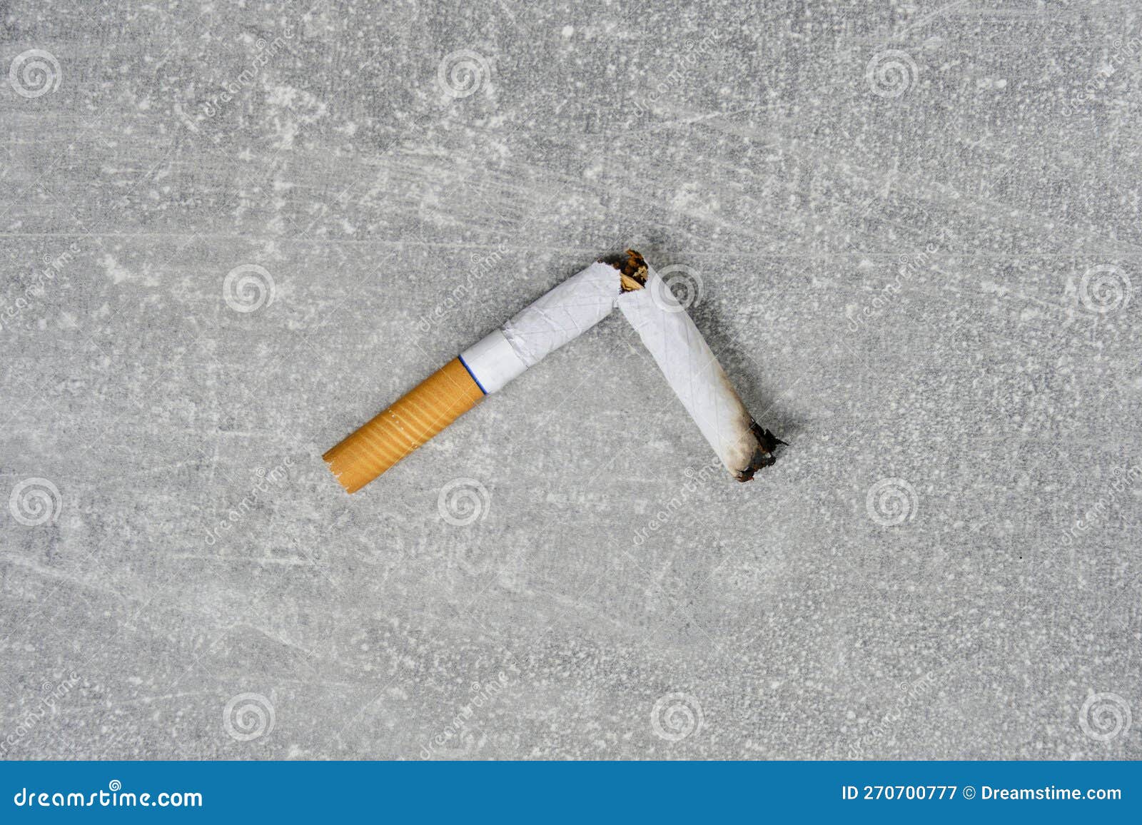 Broken in Half, Extinguished Cigarette on Gray, Concrete Floor. Stock ...