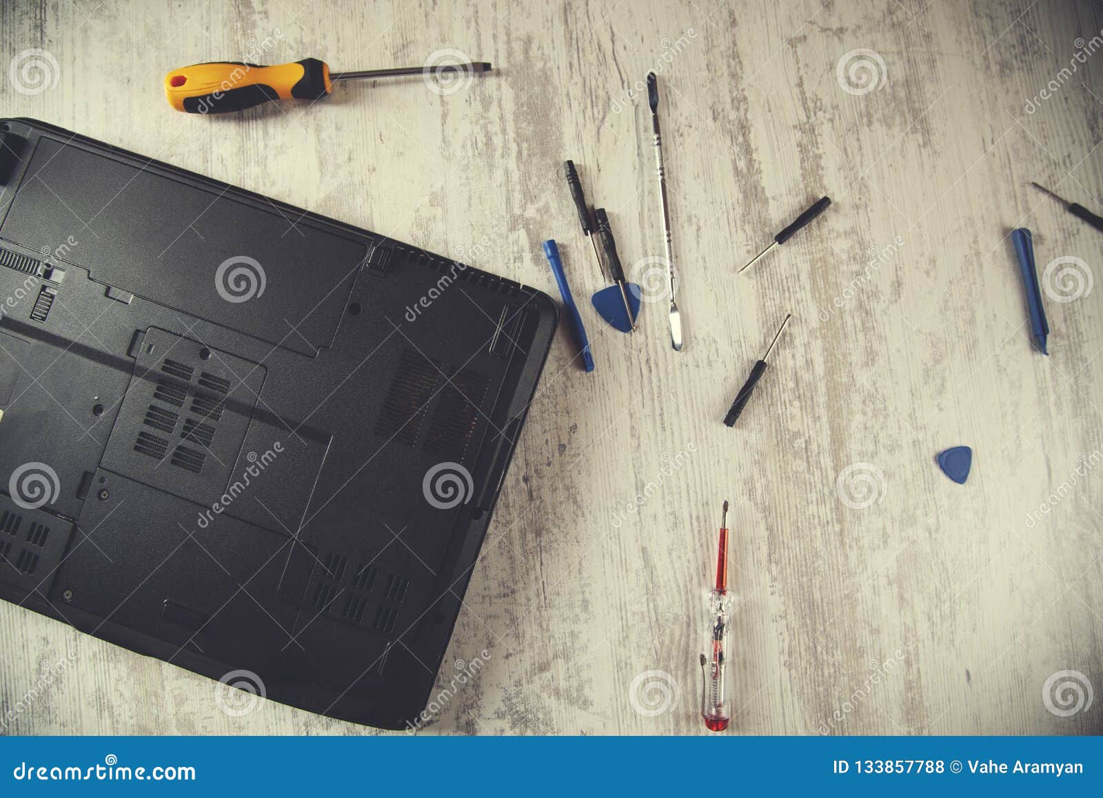 Broken laptop with tools stock photo. Image of repair - 133857788