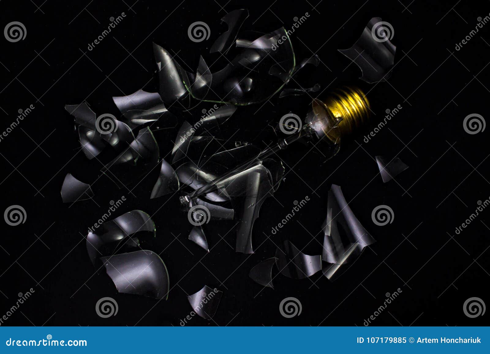Broken Light Bulb on Dark Surface with Pieces Backlit Stock Image ...
