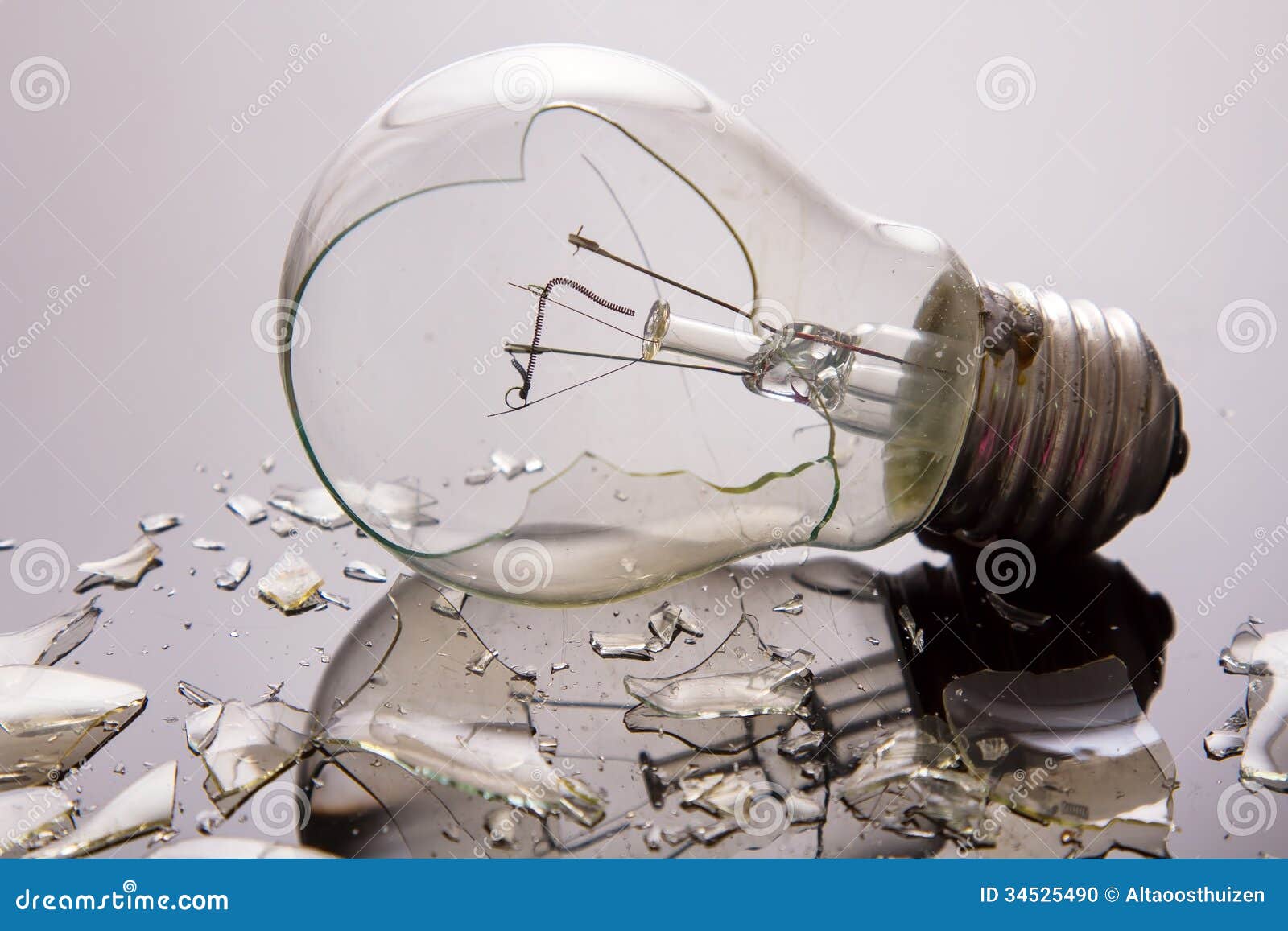 Broken Light Bulb on Shiny Surface Stock Photo - Image of reflection ...